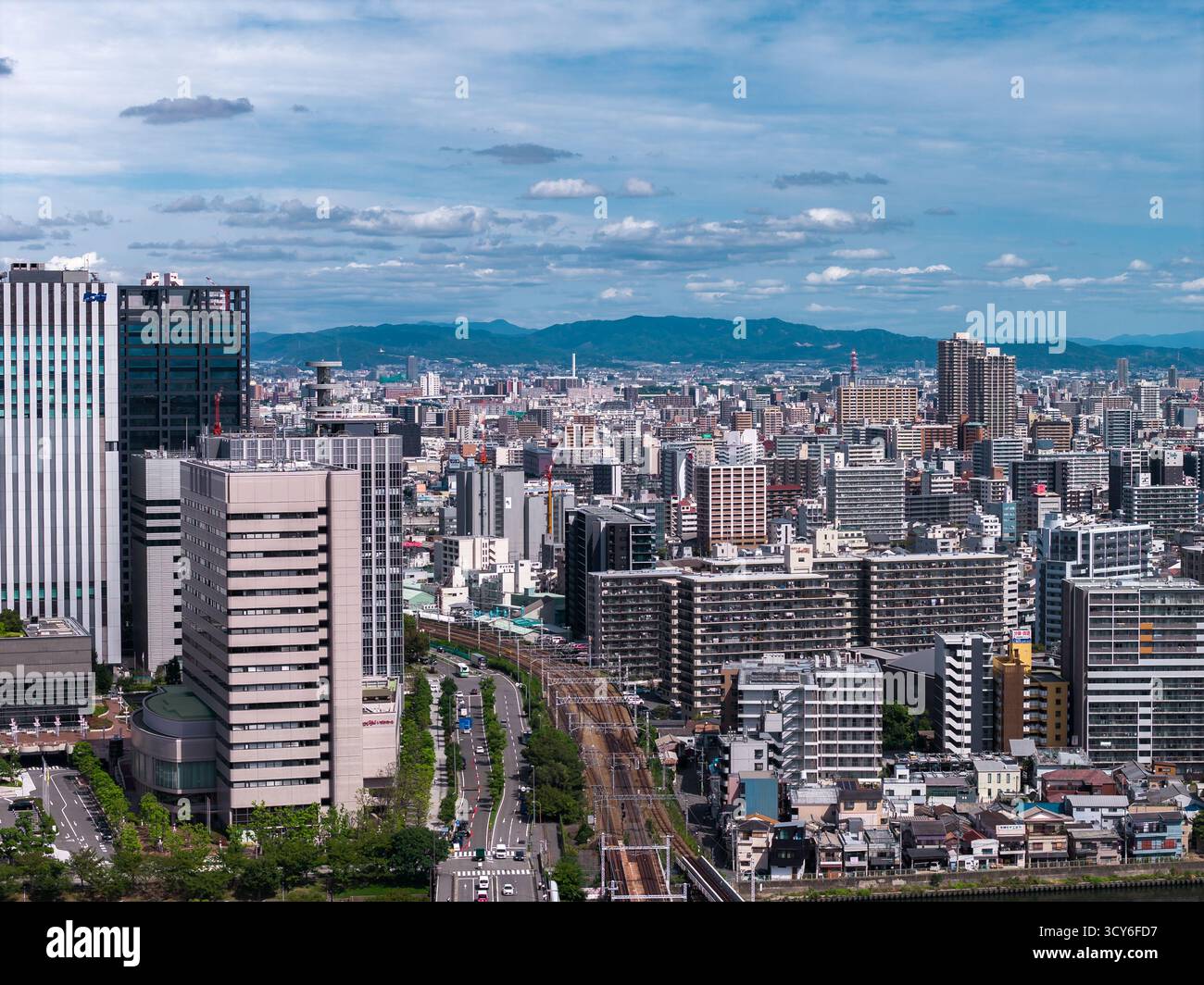 Aerial view of downtown Osaka with rail lines and high rise towers ...