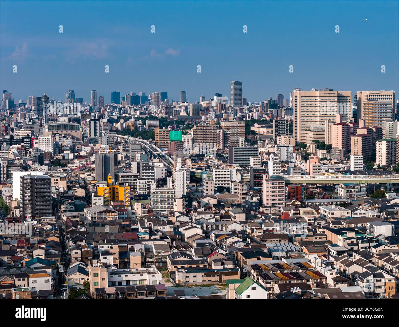 Aerial daytime view of Osaka with low rise homes and high rise towers ...