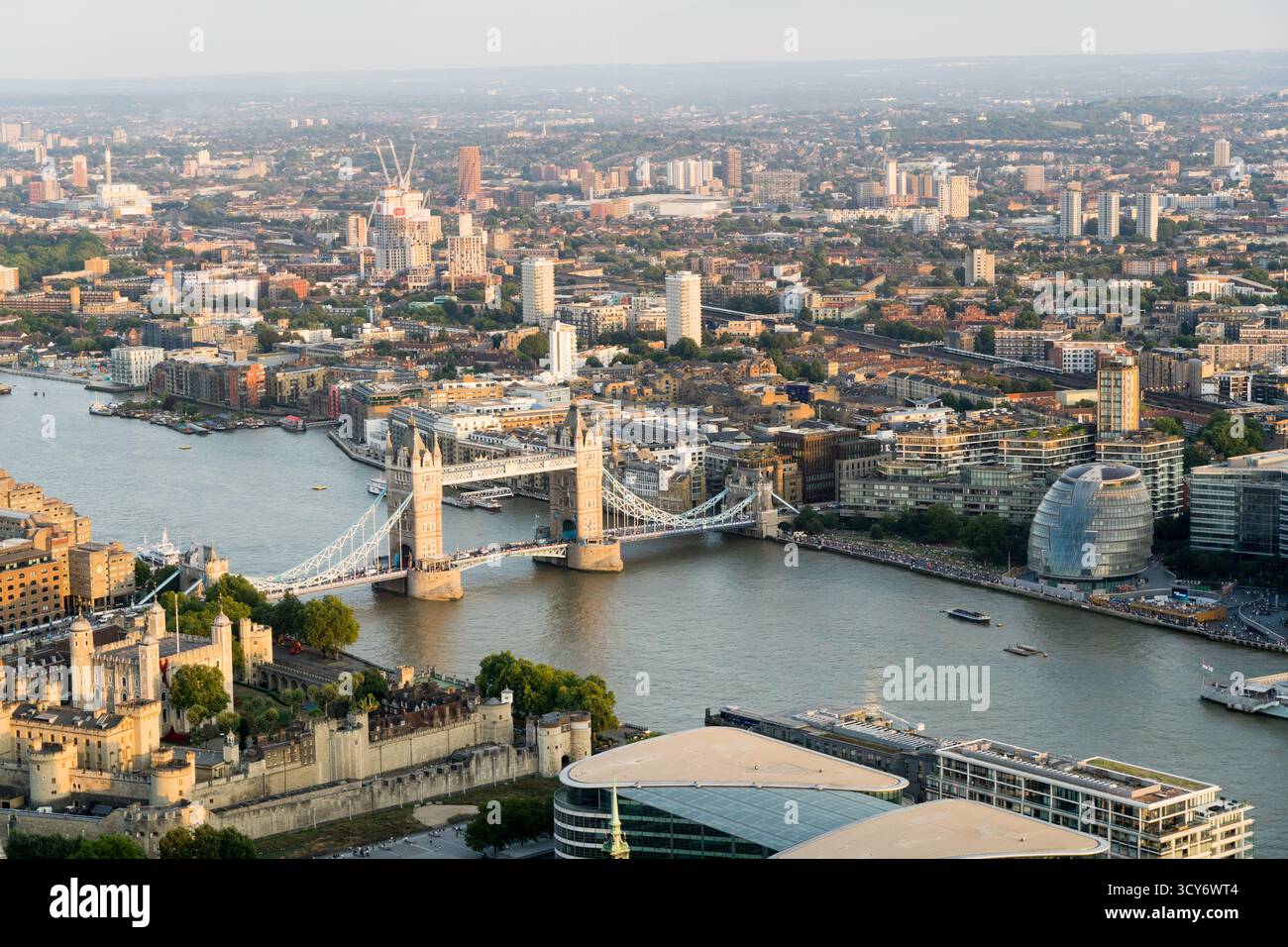 Aerial view of entire length of Tower Bridge, with surrounding London ...