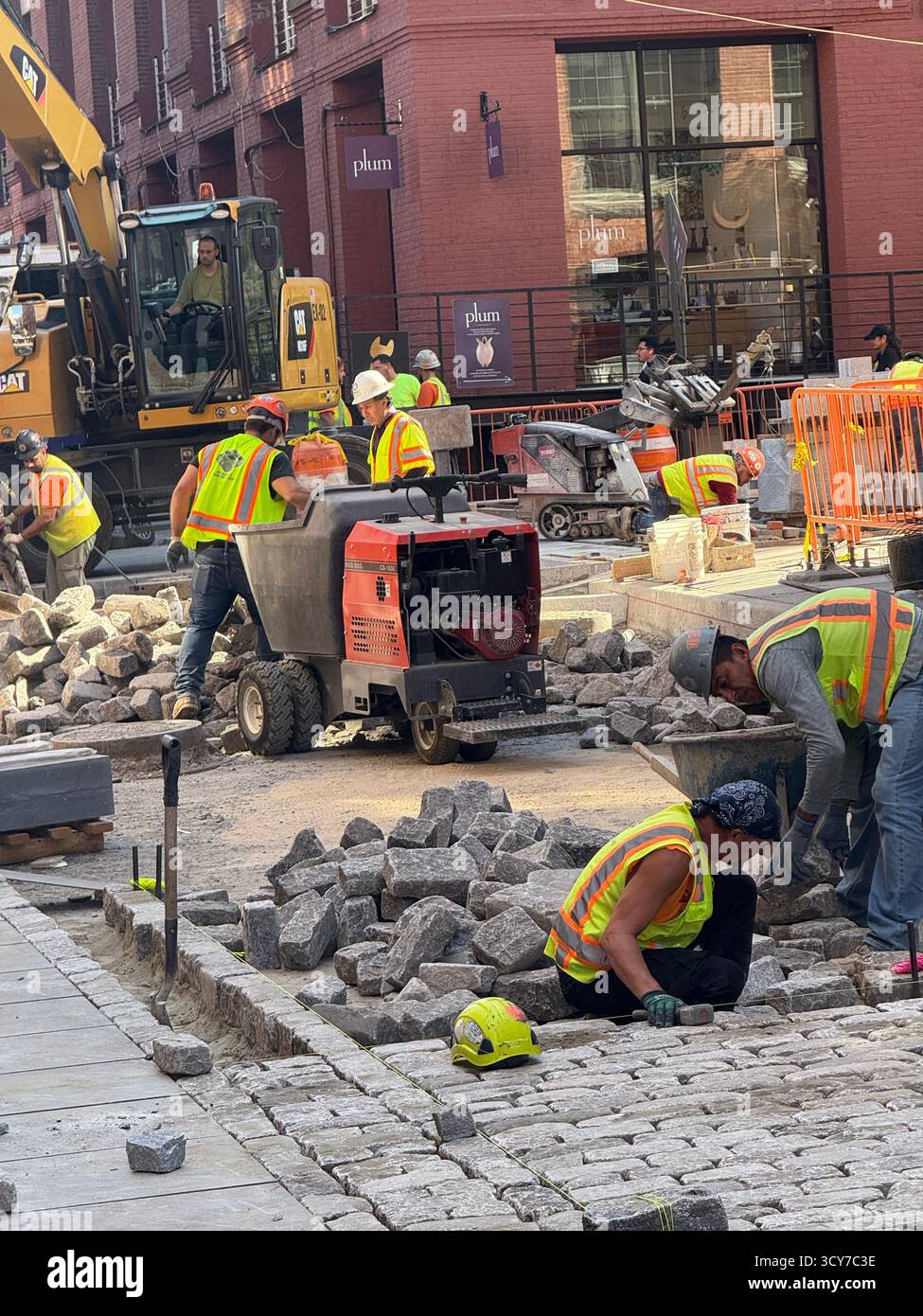 Workers repairing one of the "Belgian Block" streets in the DUMBO ...