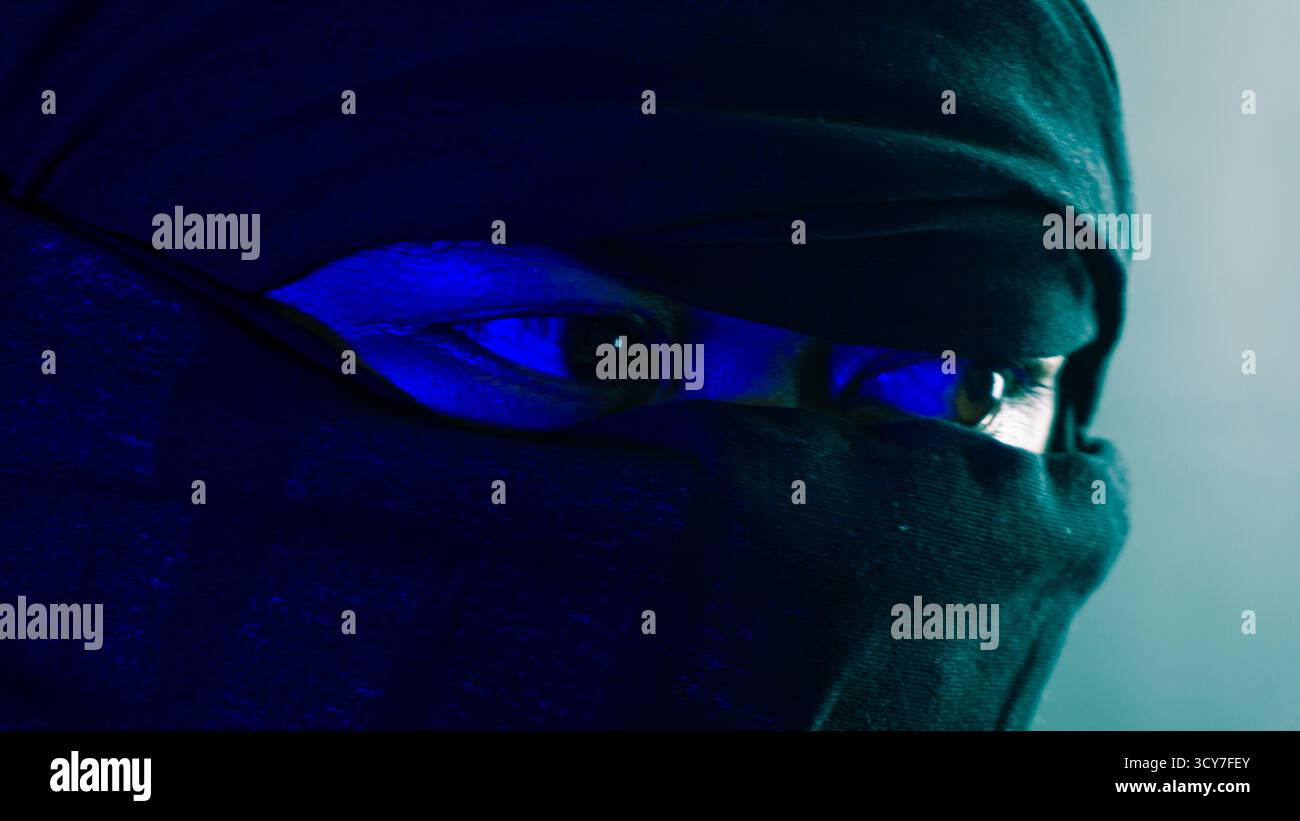 Masked male close-up with blue and green ambient light, mysterious ...
