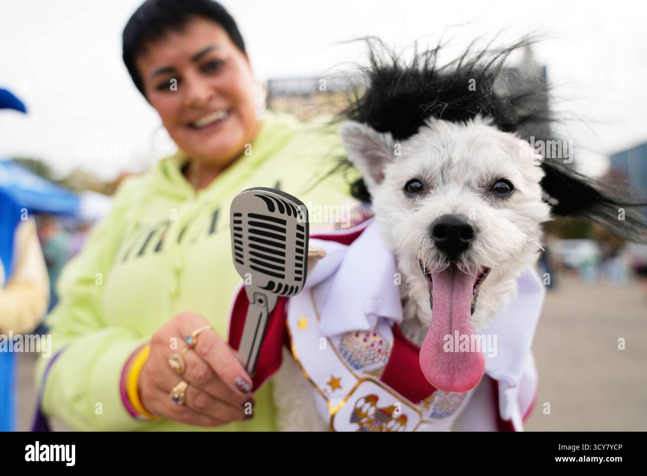 Michelle Dixon, of Laingsburg, holds her dog Abu, who is dressed as ...