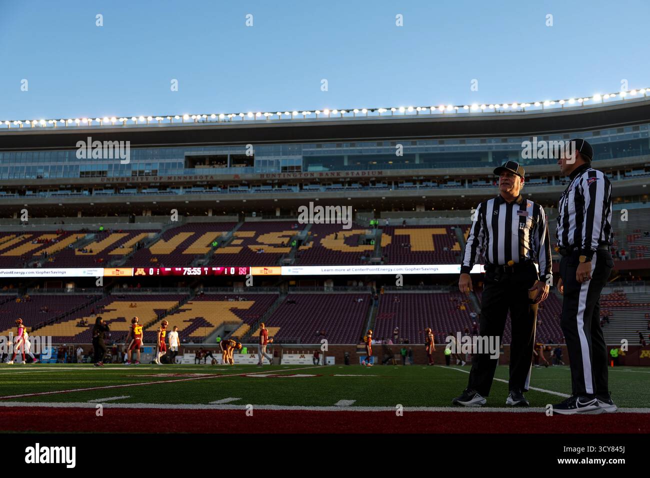 Officials converse on the field before an NCAA college football game ...
