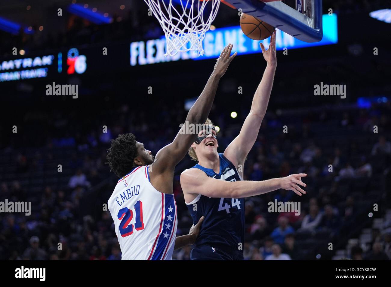 Minnesota Timberwolves' Rocco Zikarsky, right, goes up for a shot past ...