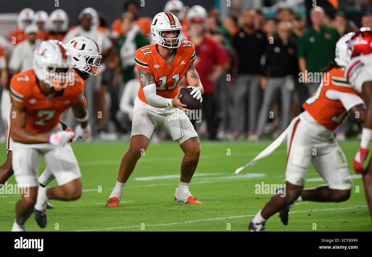 Miami quarterback Carson Beck (11) receives the ball during the first ...