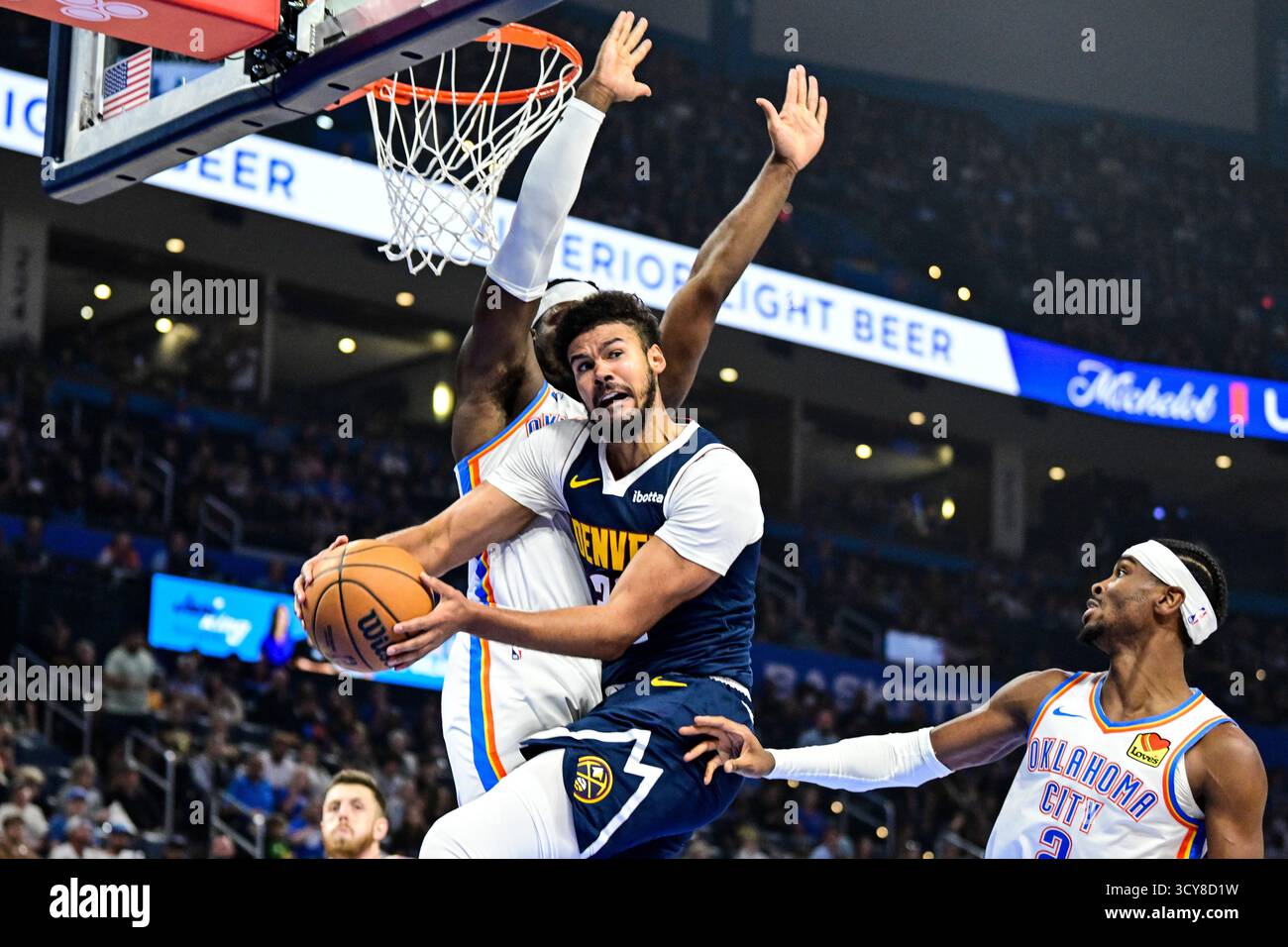 Denver Nuggets forward Cameron Johnson, center right, looks to pass the ...