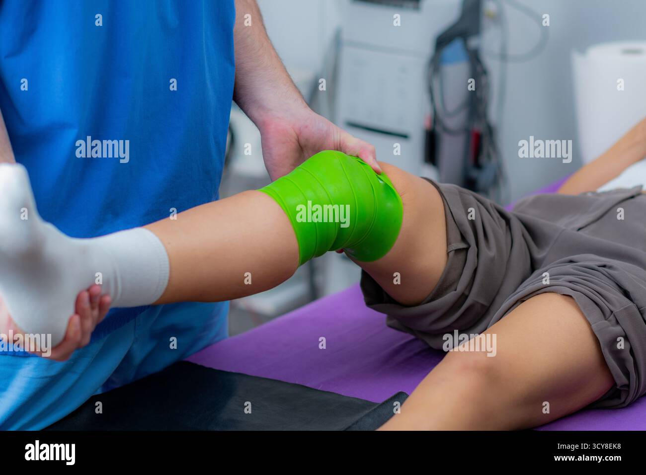 Flossing therapy on the knee is applied during a physical therapy ...