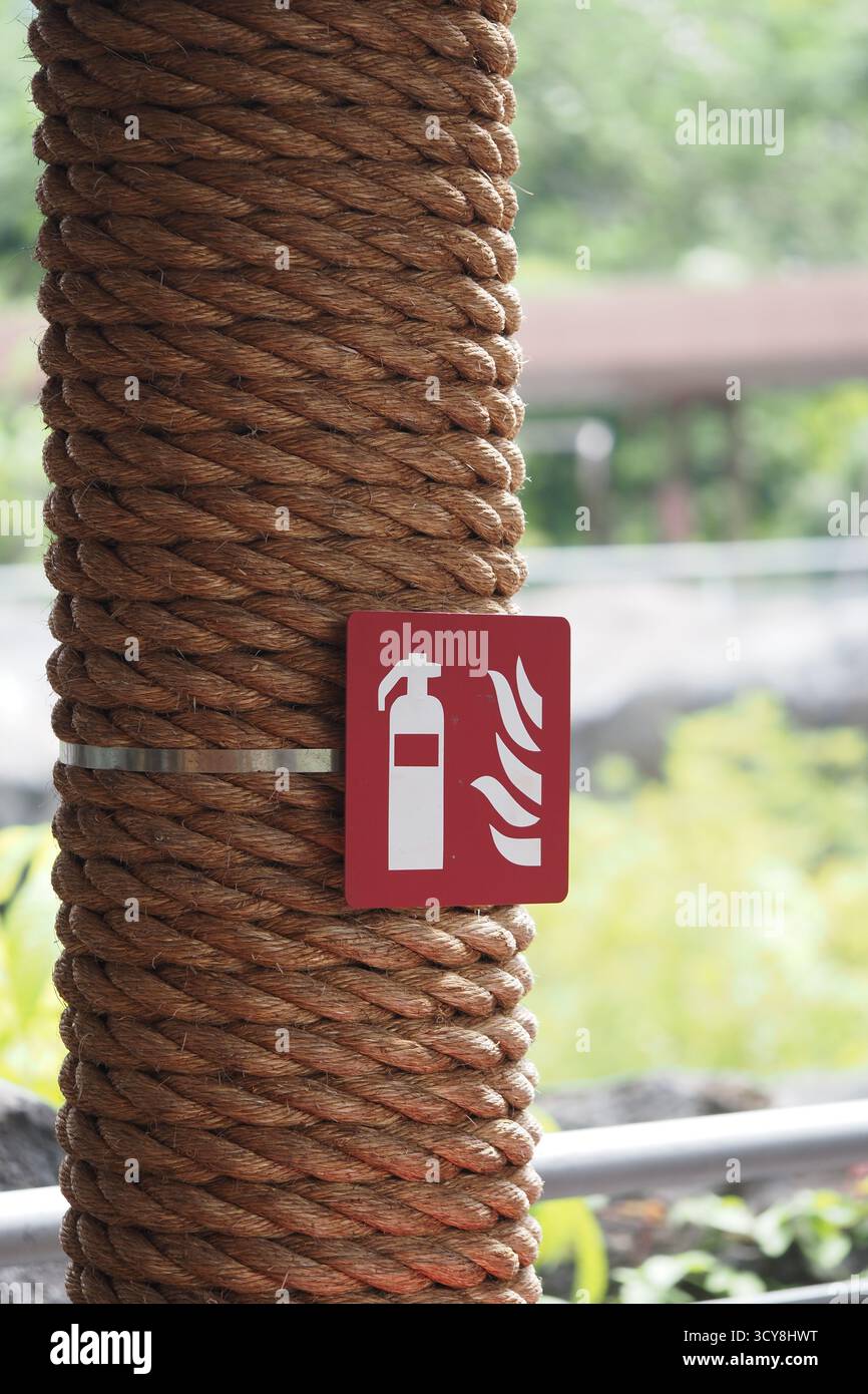 Fire safety sign on a wooden pillar in a garden area Stock Photo - Alamy