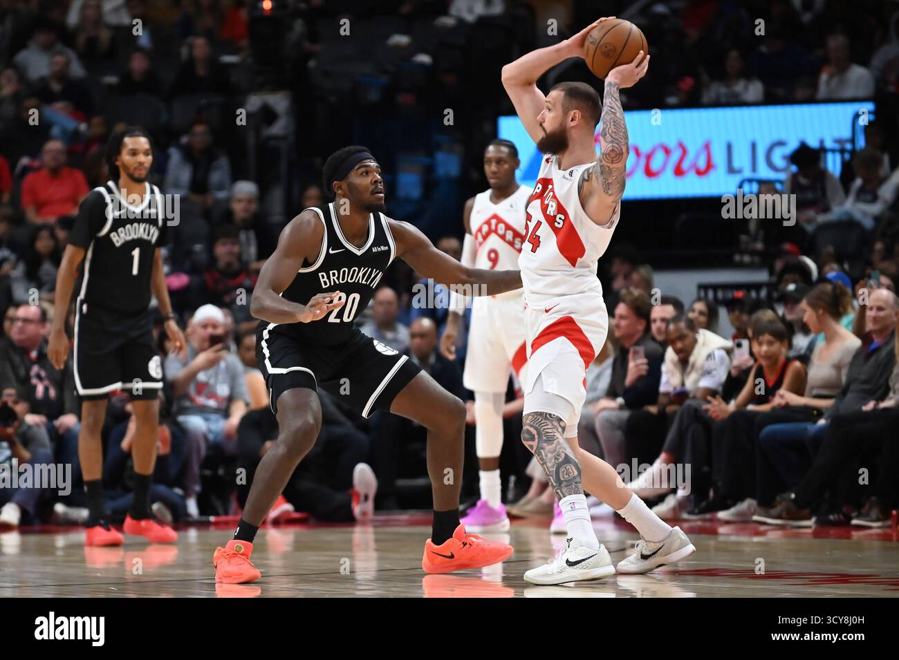 Toronto Raptors' Sandro Mamukelashvili (54) looks to pass around ...