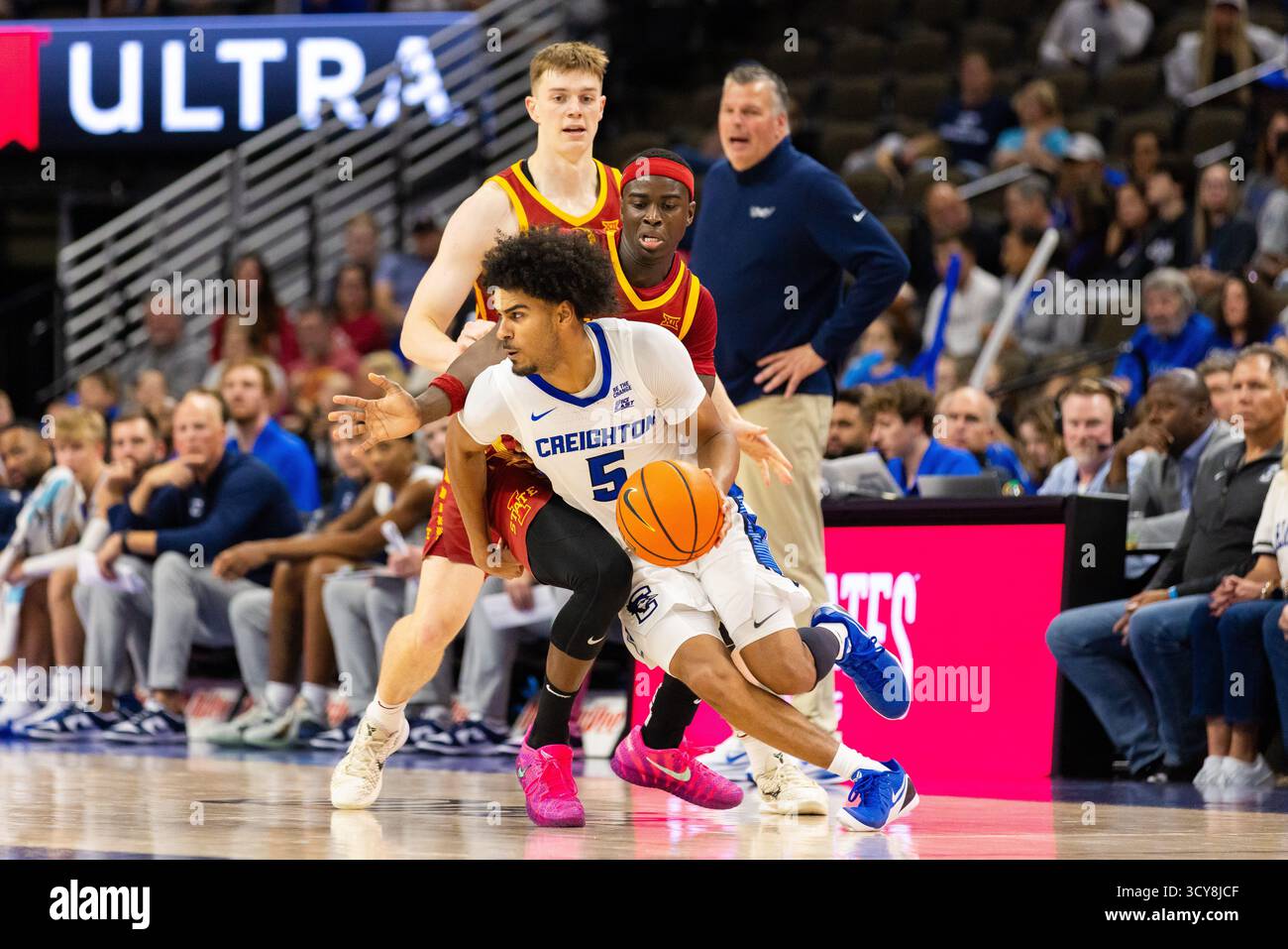 Creighton guard Nik Graves (5) drives around Iowa State guard Killyan ...