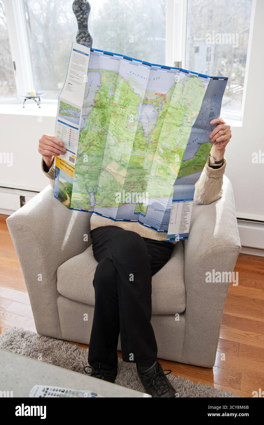 Woman looking at a paper map Stock Photo - Alamy