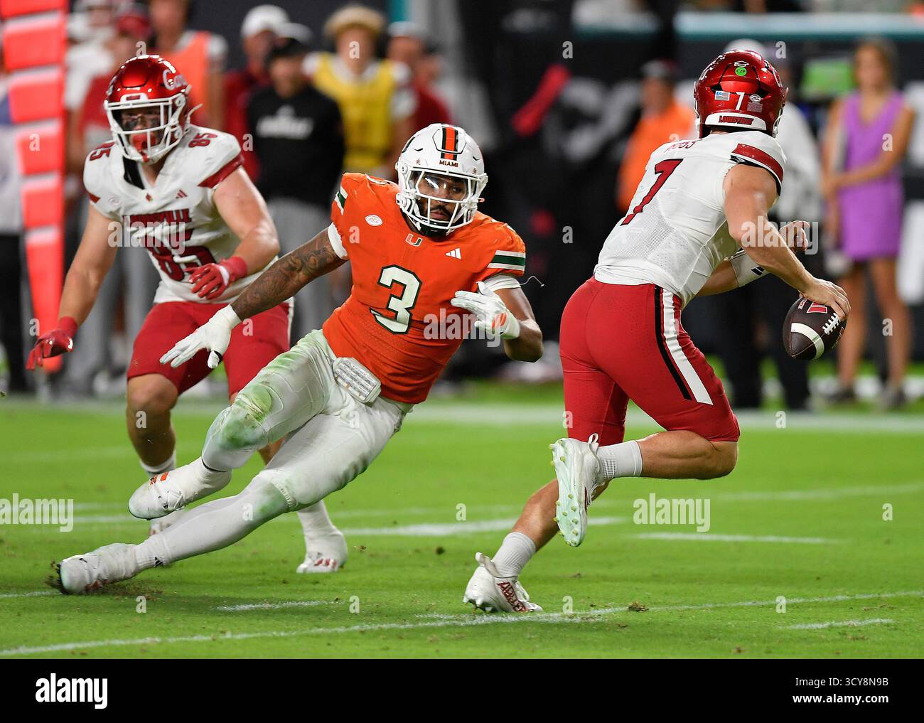 Miami defensive lineman Akheem Mesidor (3) chases Louisville ...