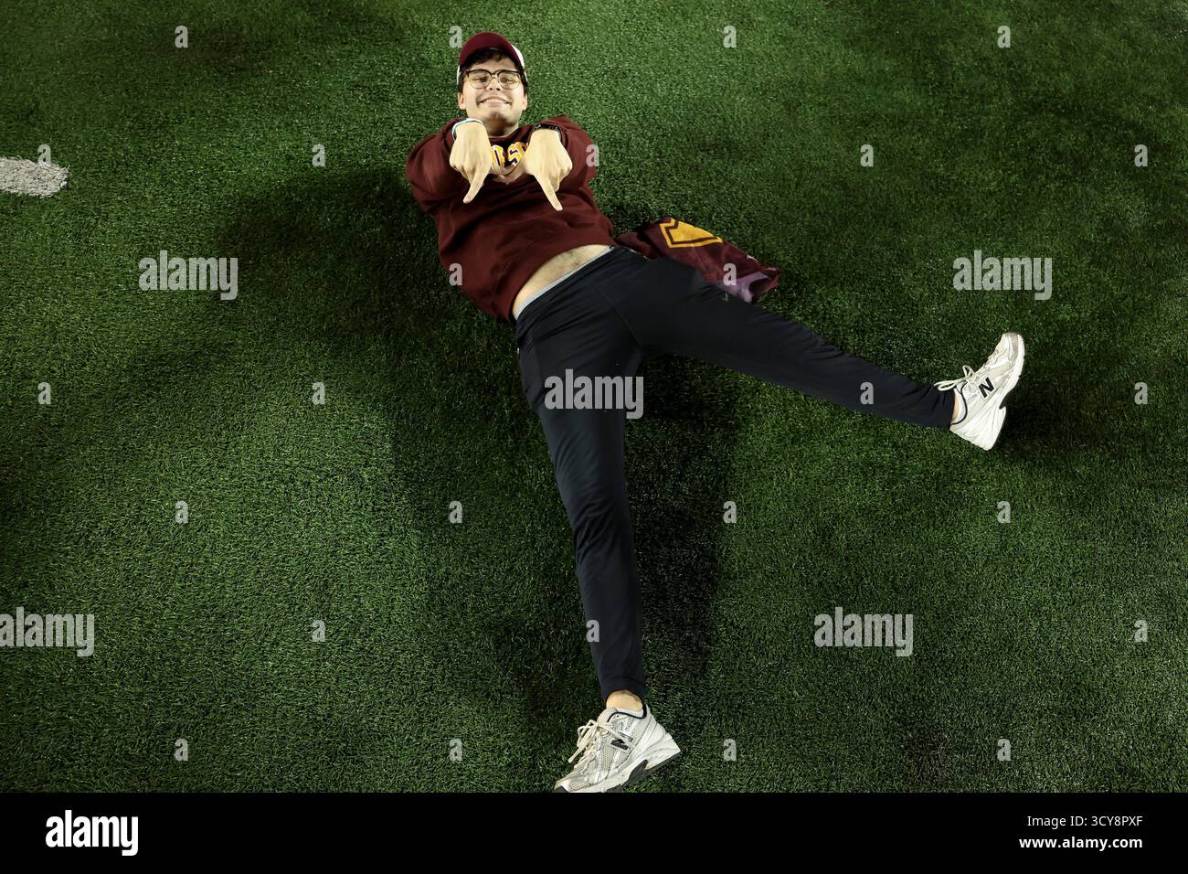 Minnesota student Matthew Swenson celebrates on the field after the ...
