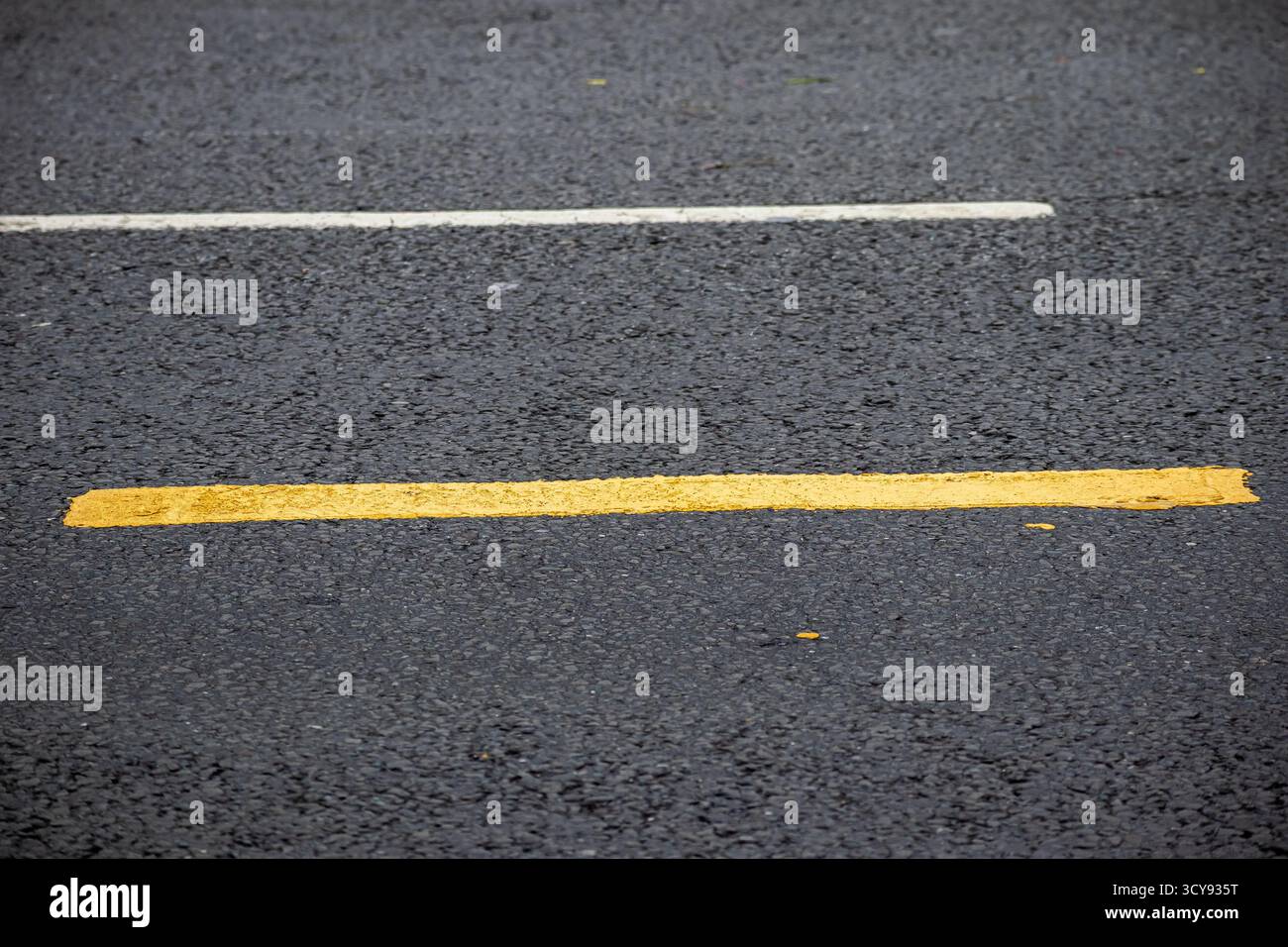 Yellow and white road markings on tarmac Stock Photo - Alamy