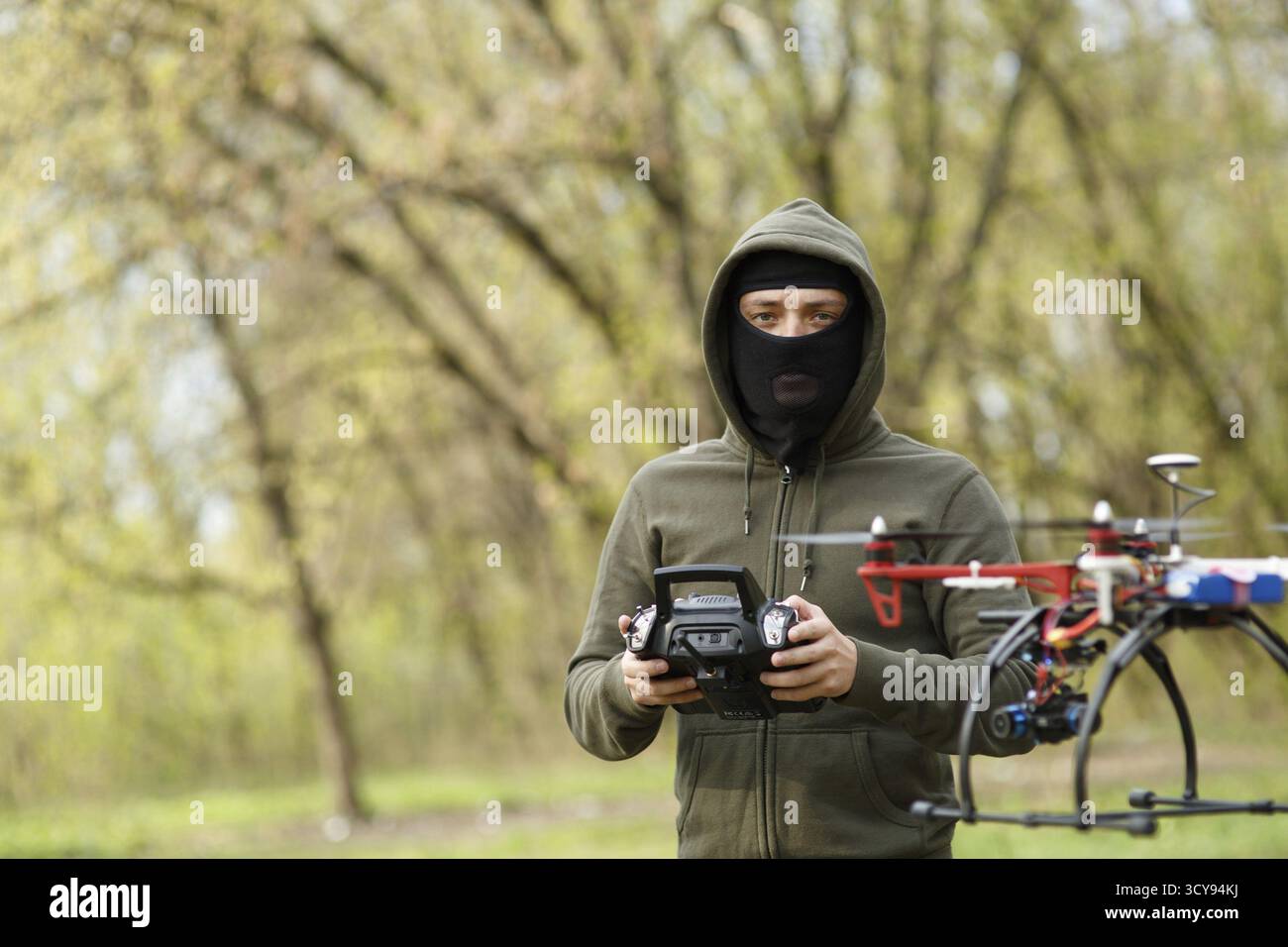 Man in mask flying with the drone. Technology thief concept Stock Photo ...