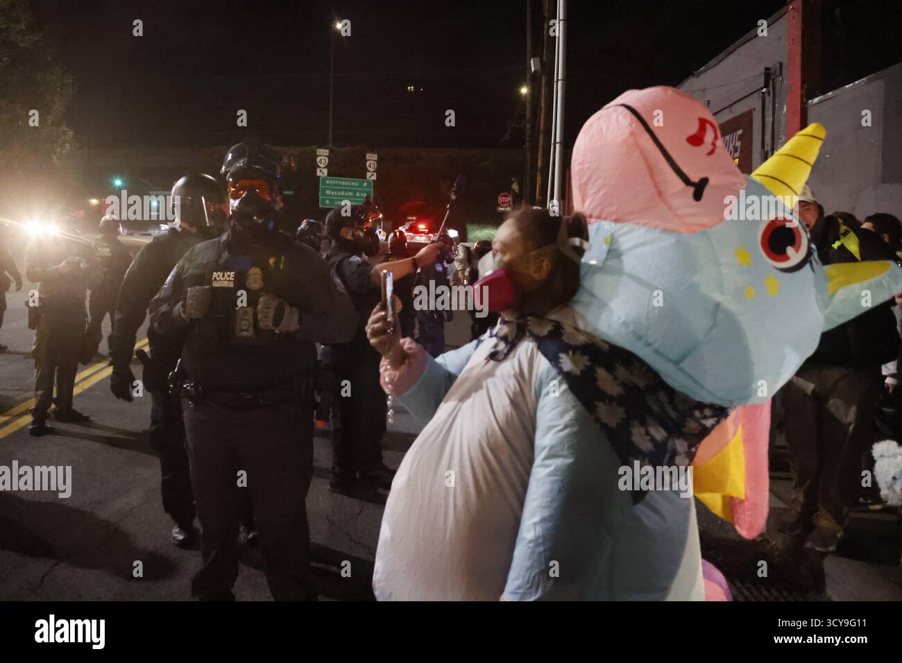 PORTLAND, OR – OCTOBER 17, 2025: After dark, protesters converged ...