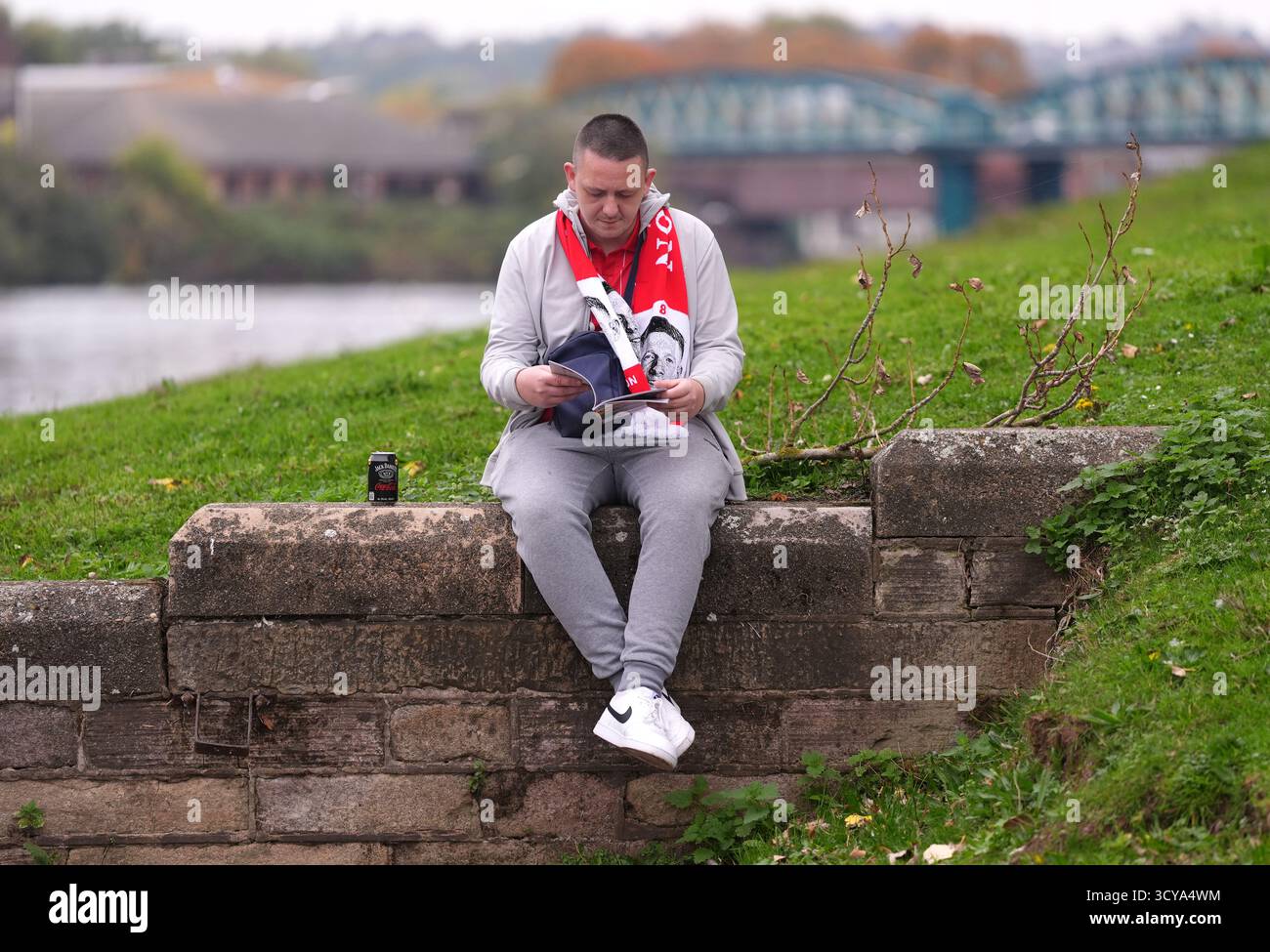 A Nottingham Forest fan reads the programme ahead of the Premier League ...