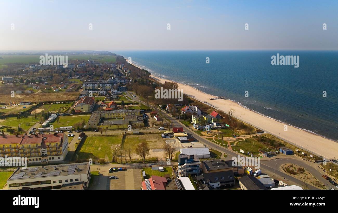 Smooth Baltic waves near Sarbinowo under sunlight, wide beach and ...