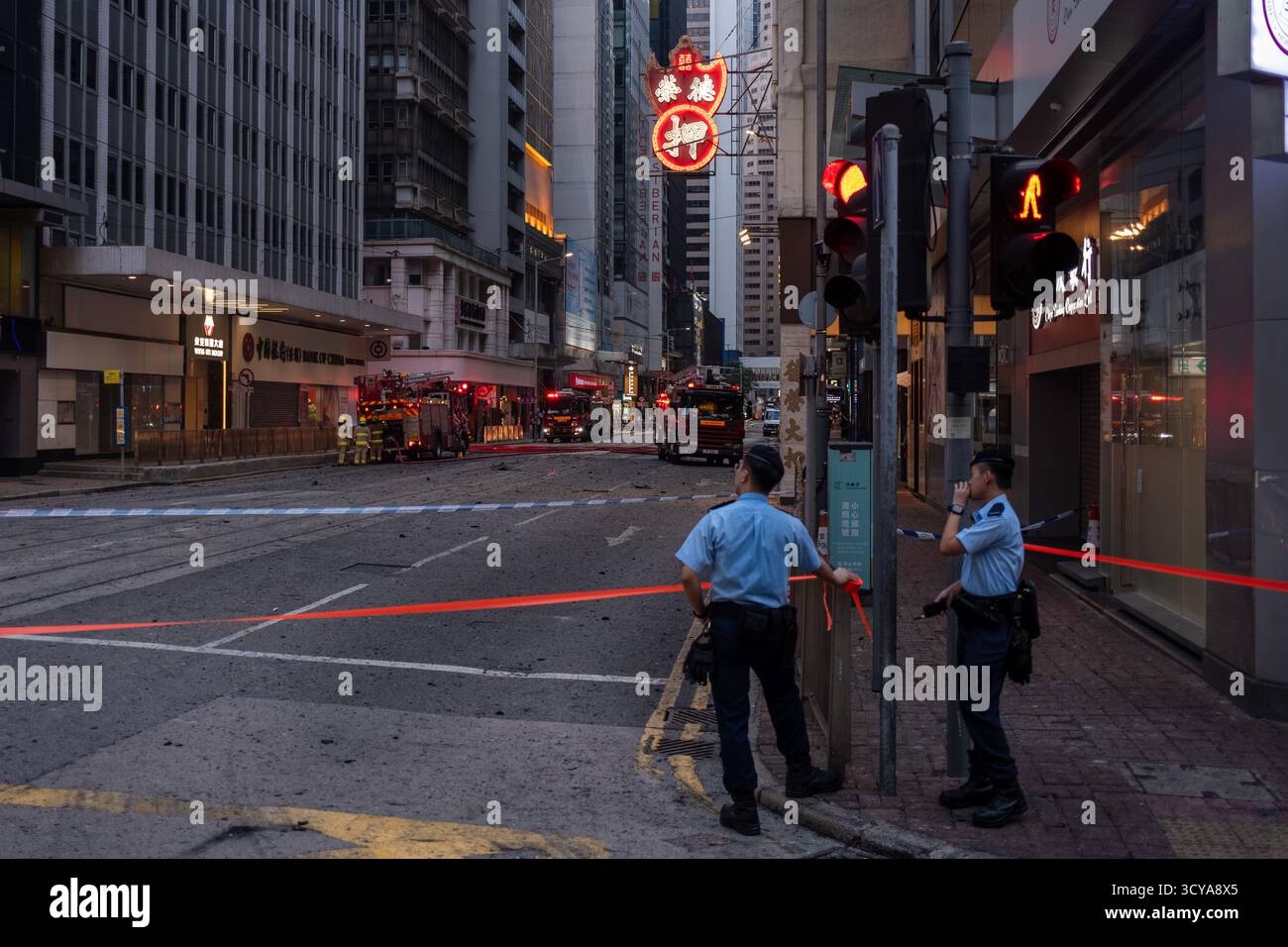 Police officers cordon off a road near the scene of the fire in central ...