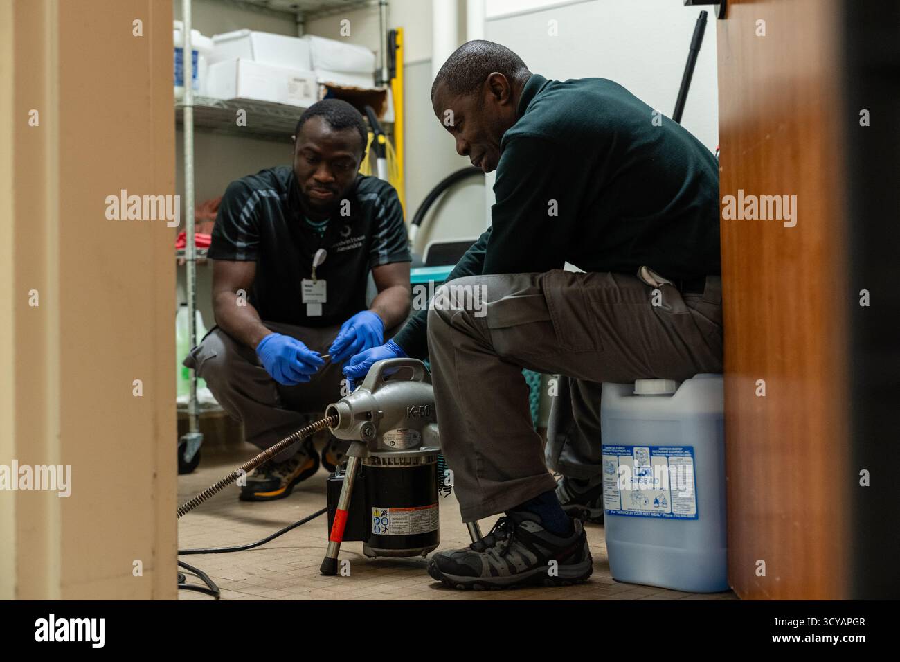 Maintenance workers Melvin Palmer, left, originally from Sierra Leone ...