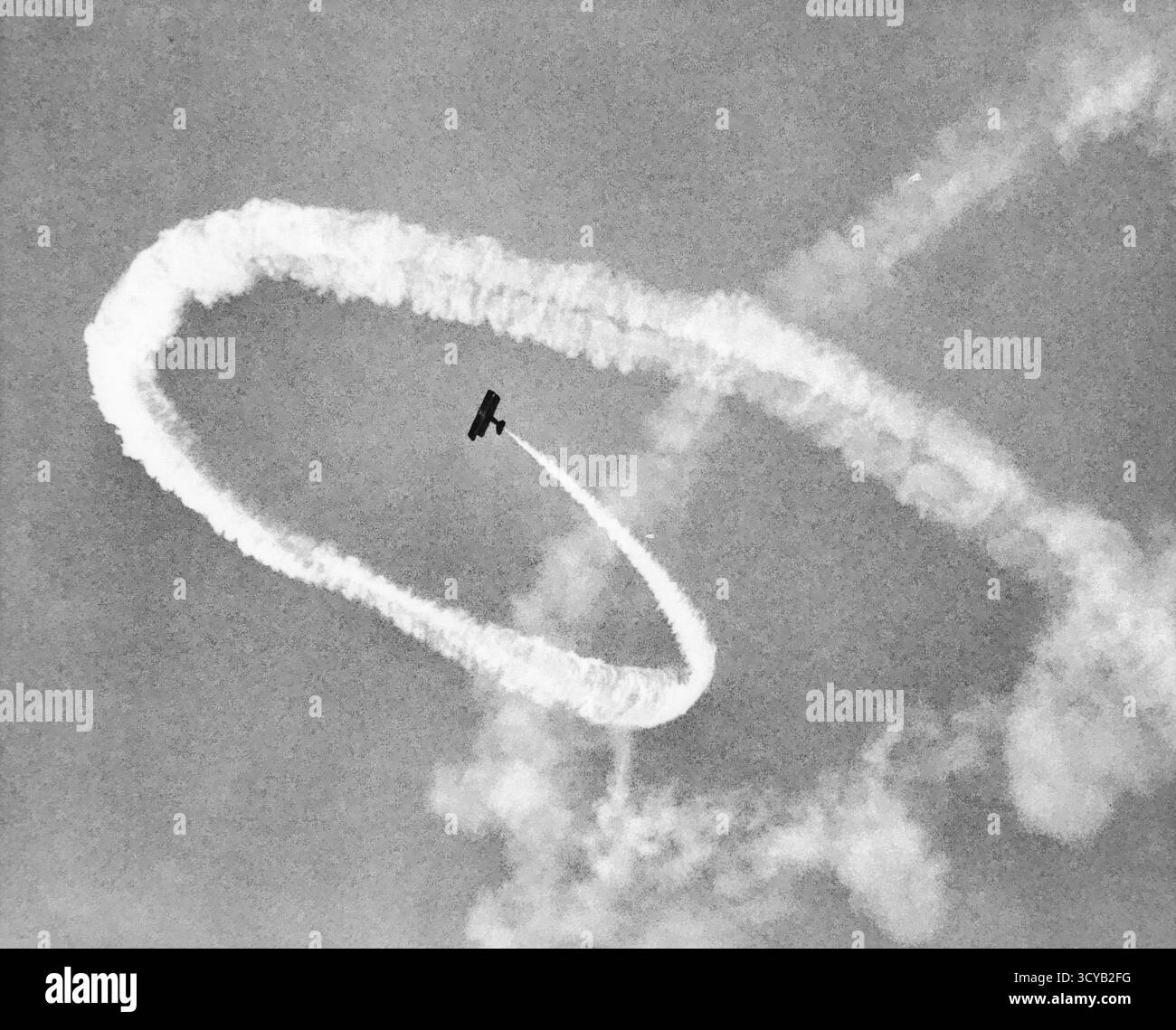 A biplane performing aerobatics with smoke trails Stock Photo - Alamy