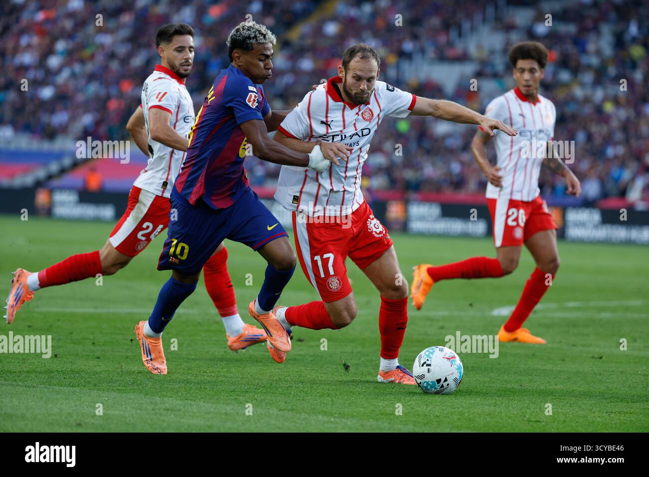 Barcelona's Lamine Yamal, left, and Girona's Daley Blind fight for the ...