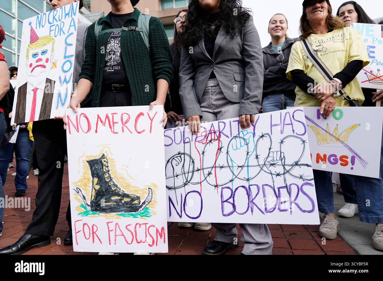 Demonstrators carry signs as they rally at the 14th and U street ...