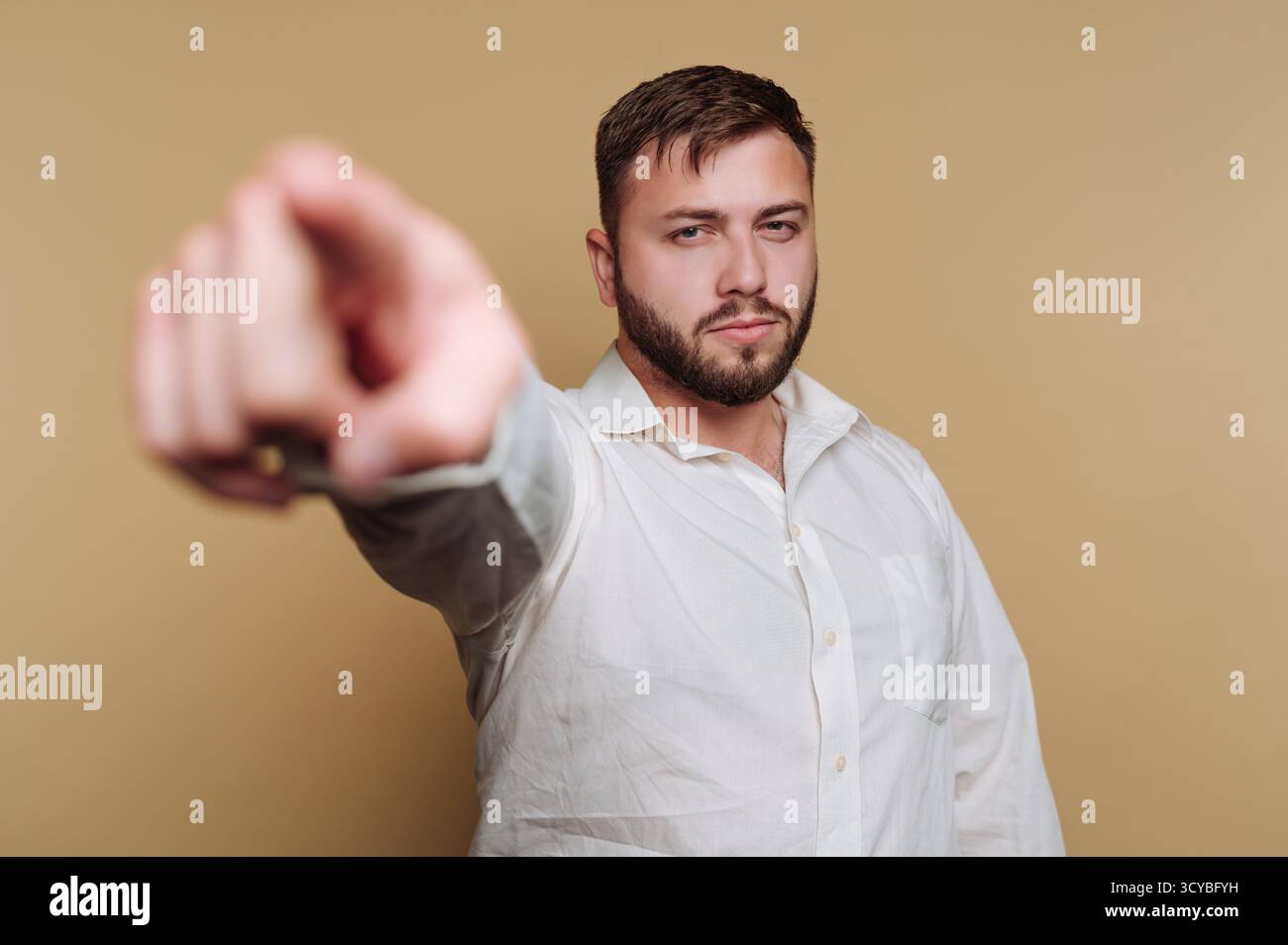 Positive young man pointing viewer hi-res stock photography and images ...
