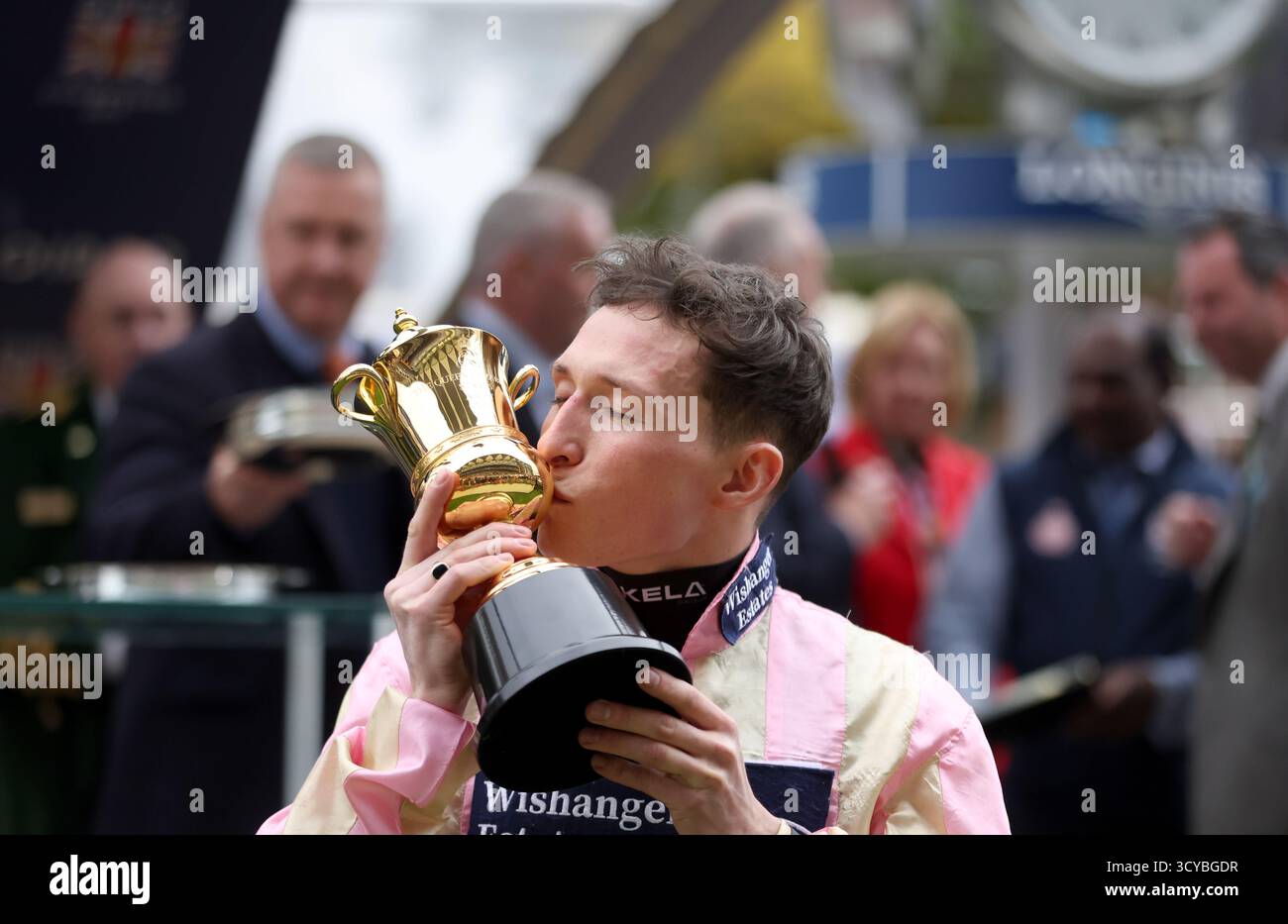 Jockey Jason Watson kisses the trophy after winning the Queen Elizabeth ...