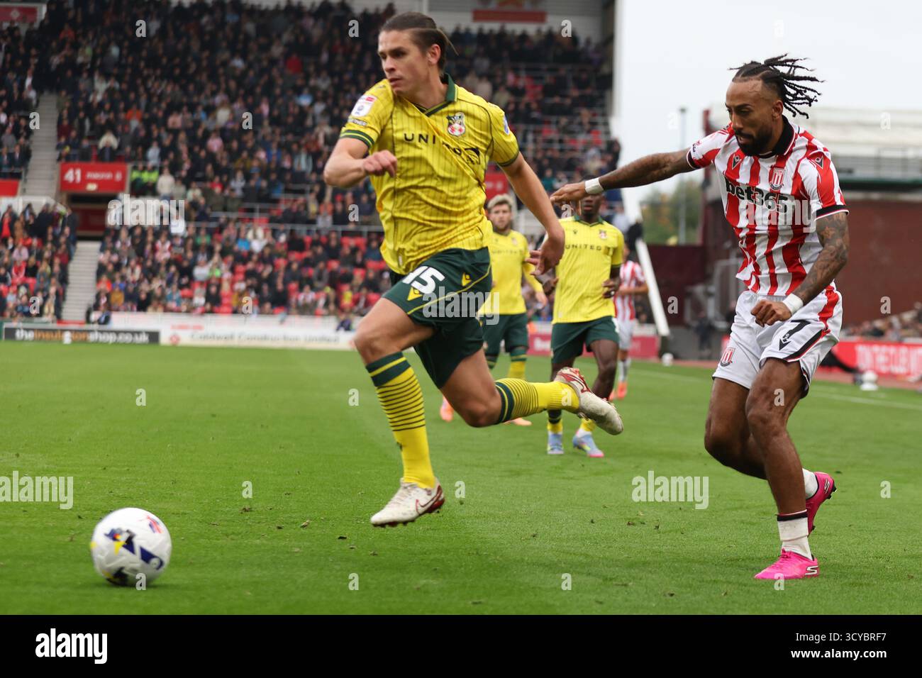 Wrexham’s George Dobson (left) and Stoke City's Sorba Thomas battle for ...