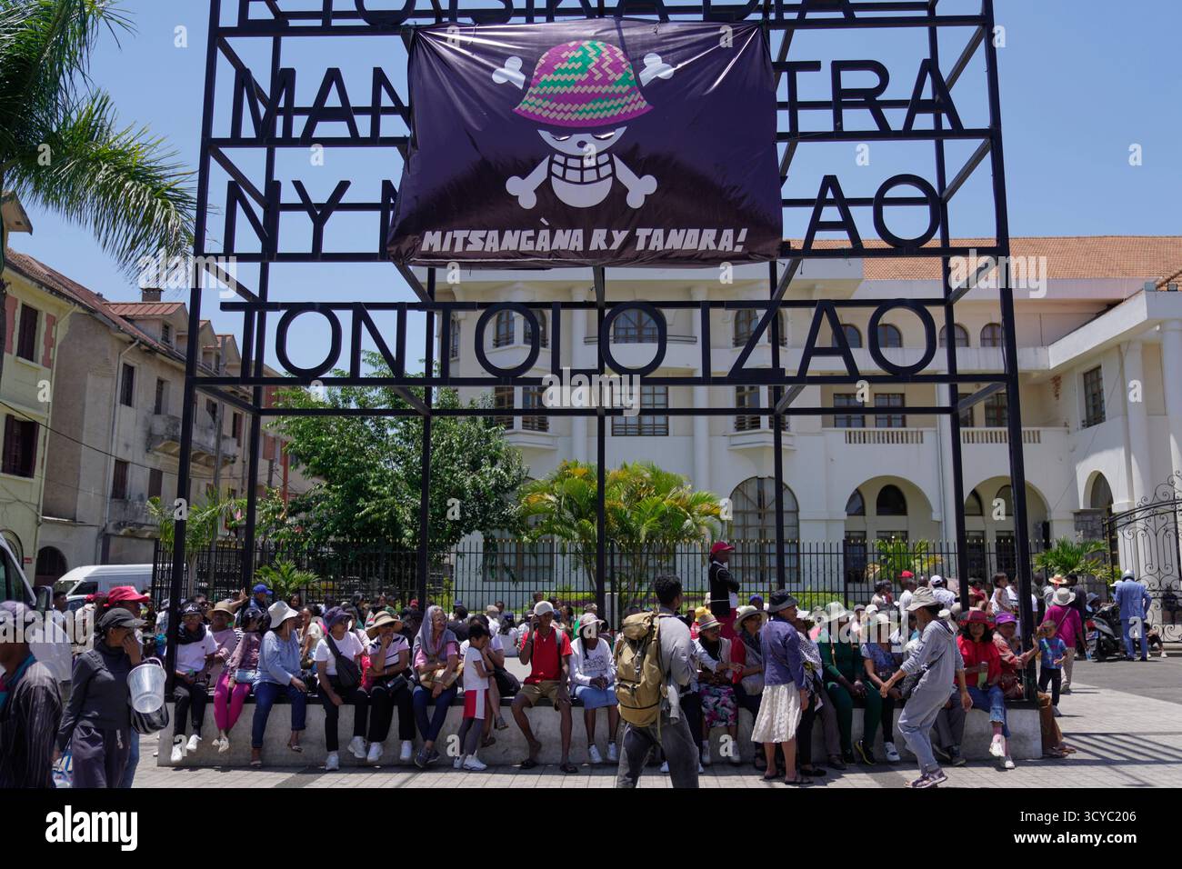 People gather beneath a skull and crossbones banner at May 13 Square in ...