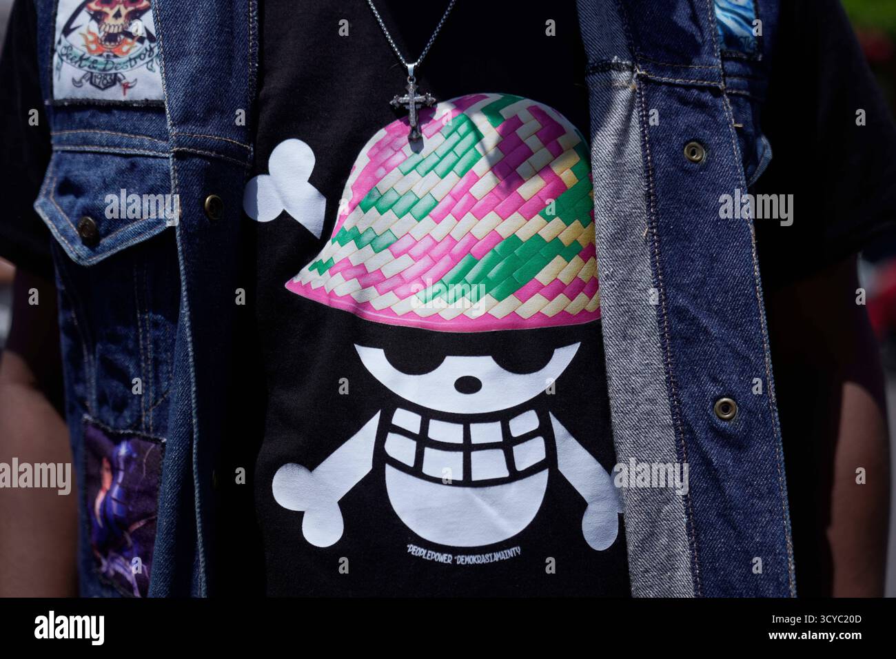 A man wears a skull and crossbones t-shirt during a gathering at May 13 ...