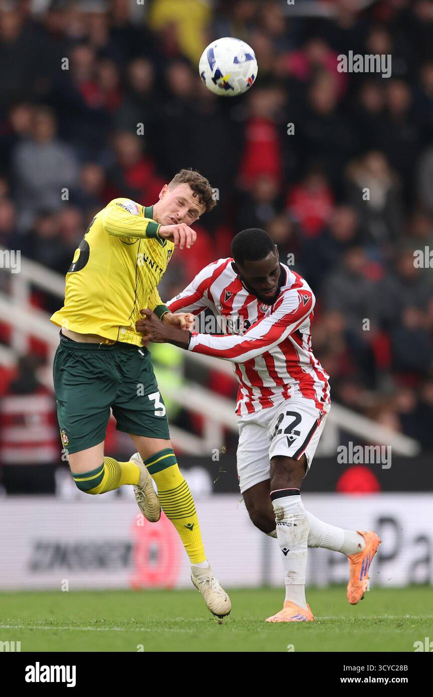 Stoke City's Junior Tchamadeu (right) and Wrexham's Lewis Brunt battle ...