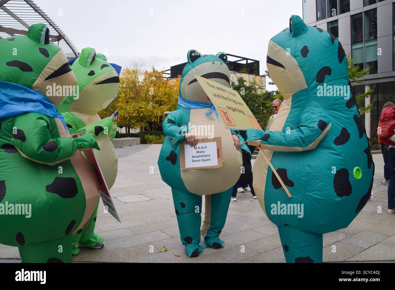 London, UK. 18th October 2025. Protesters wearing inflatable frog ...
