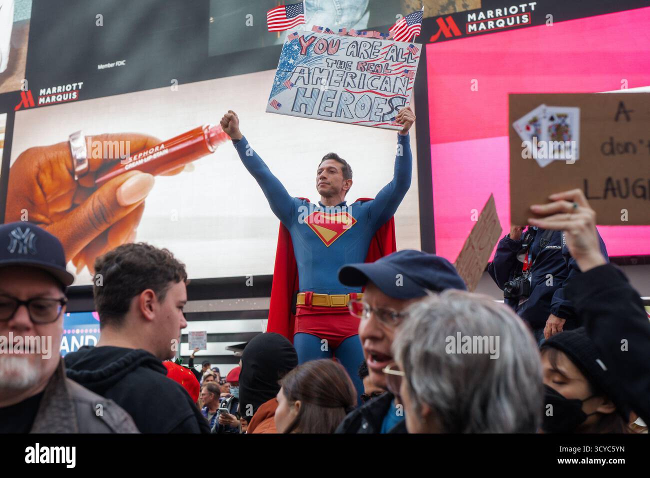 Protester dressed as Superman holds a sign during a "No Kings" protest ...