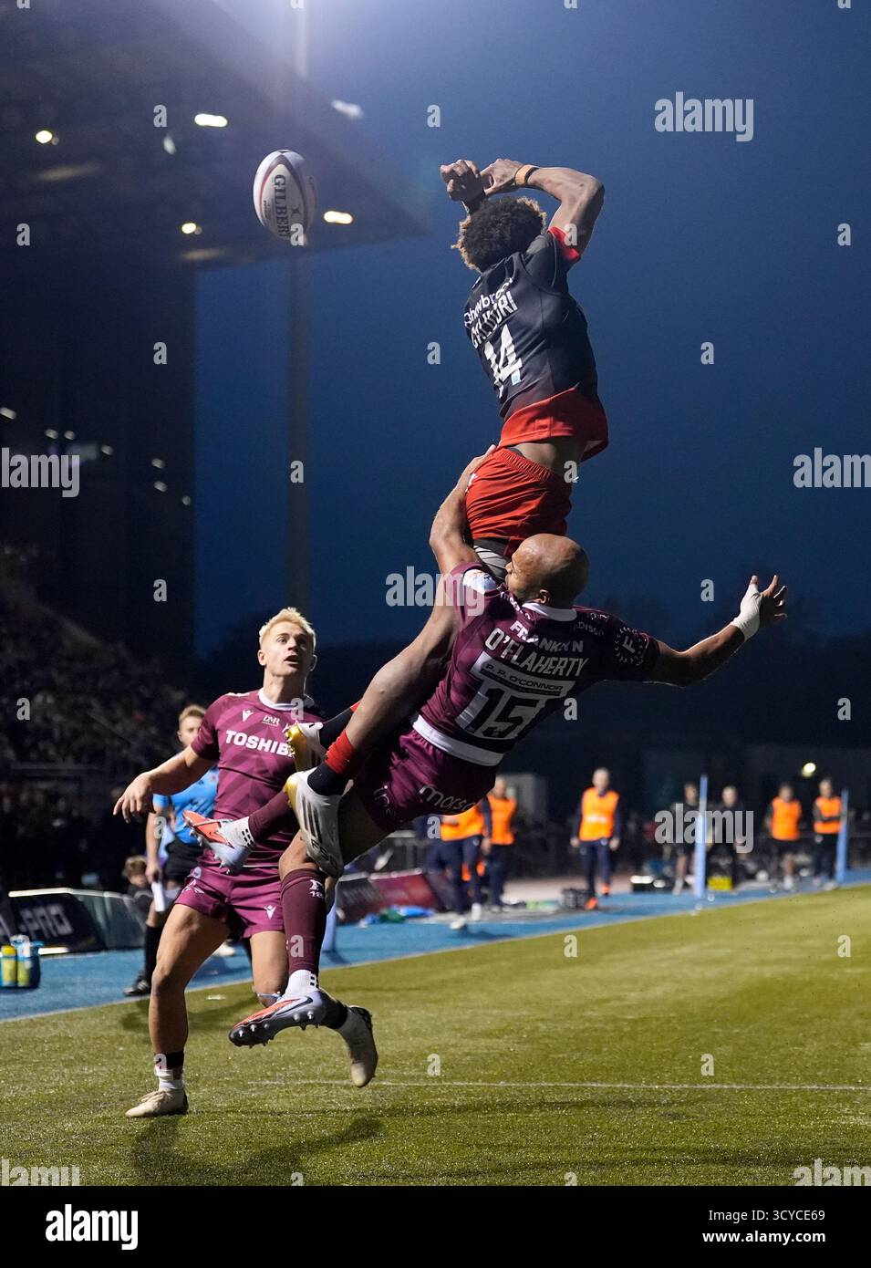 Saracens' Noah Caluori (top) fails to take hold of a high ball during ...