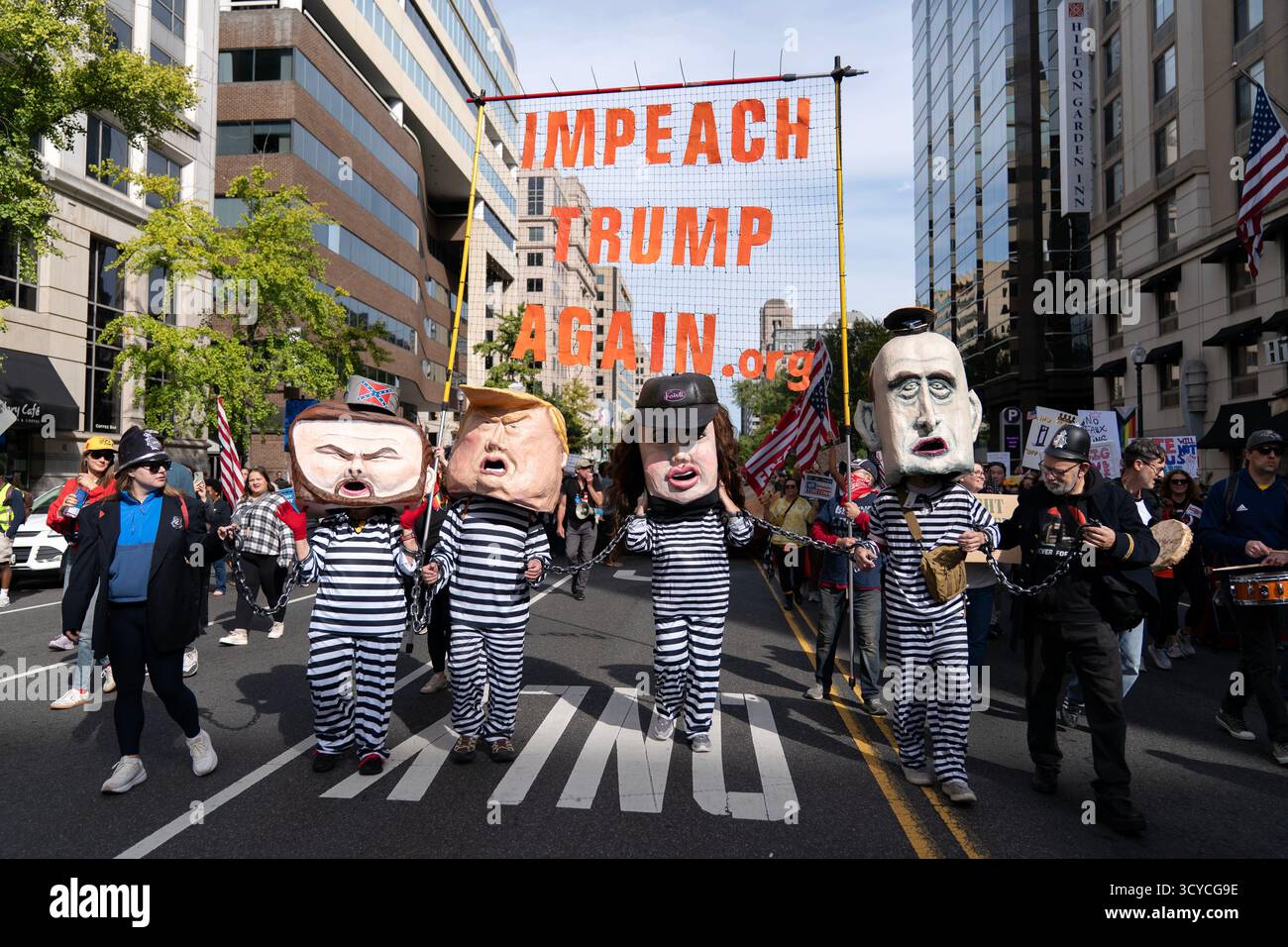 Demonstrators wear costumes and carry signs as they march to the ...