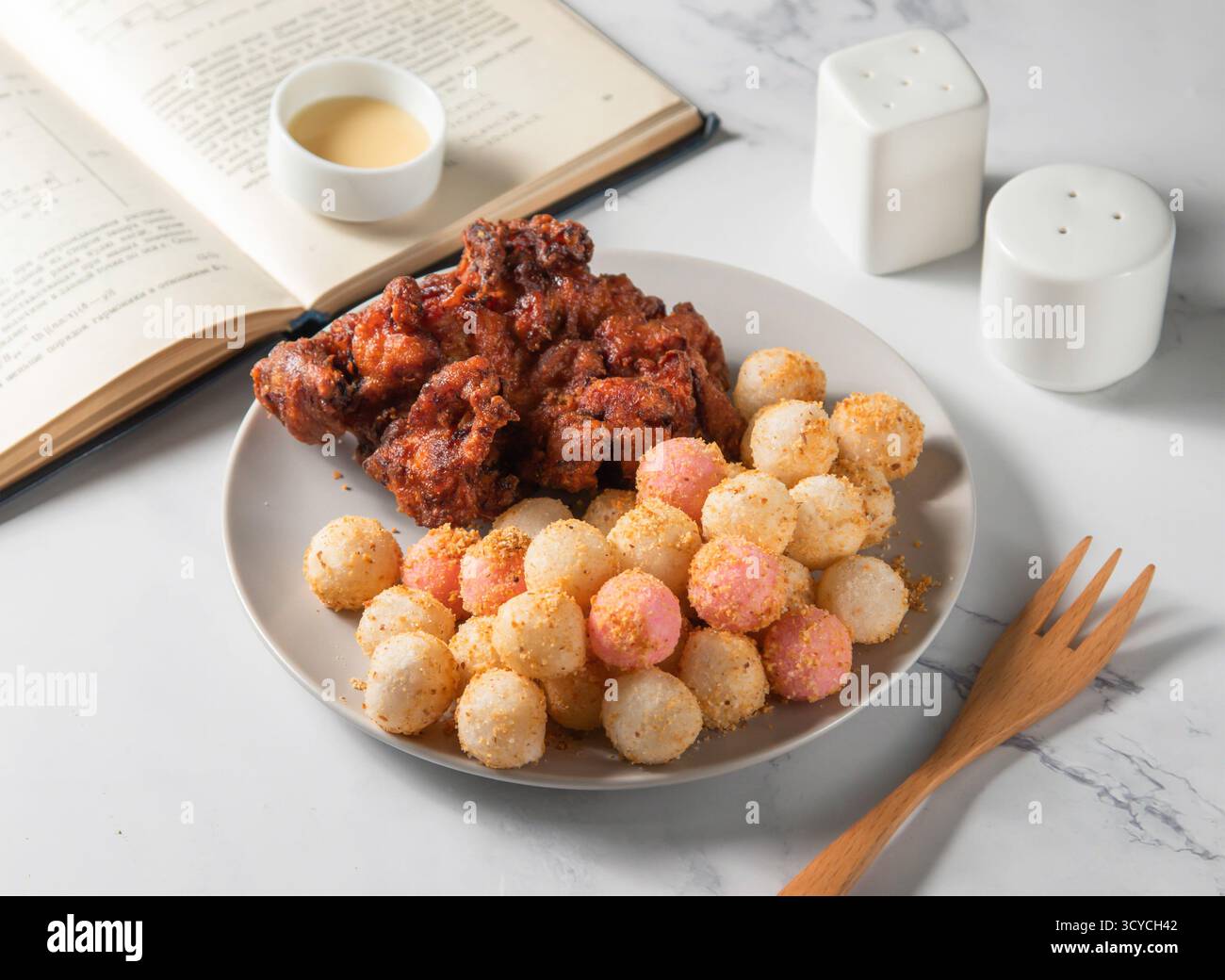 Fried Chicken thigh steak and fried rice balls with sauce served in ...