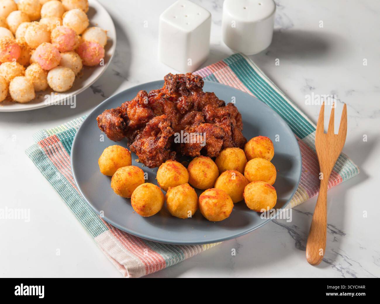 Fried Chicken thighs, sweet potato balls and fried rice balls served in ...