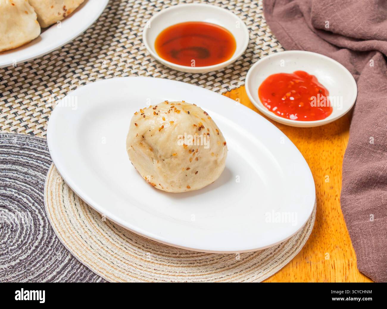 Shanghai Fried Buns or Momo with Dipping Sauce served in plate isolated ...