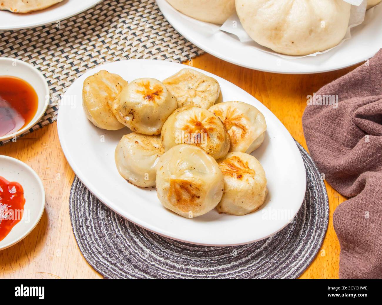 Shanghai Fried Buns 8 piece with Dipping Sauce served in plate isolated ...