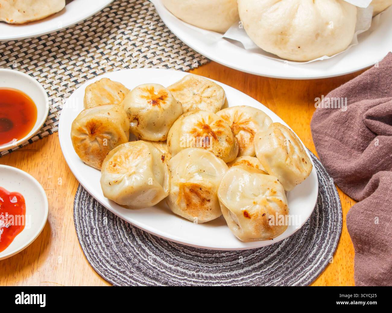 Shanghai Fried Buns 12 piece with Dipping Sauce served in plate ...