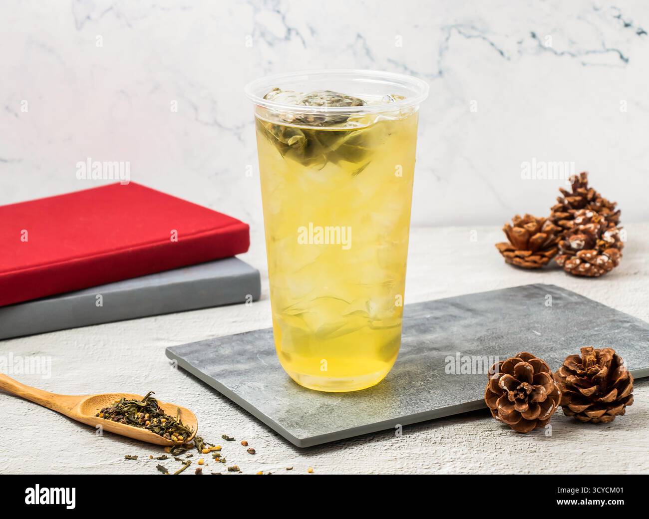 Iced Buckwheat Green Tea served in disposable glass isolated on board ...