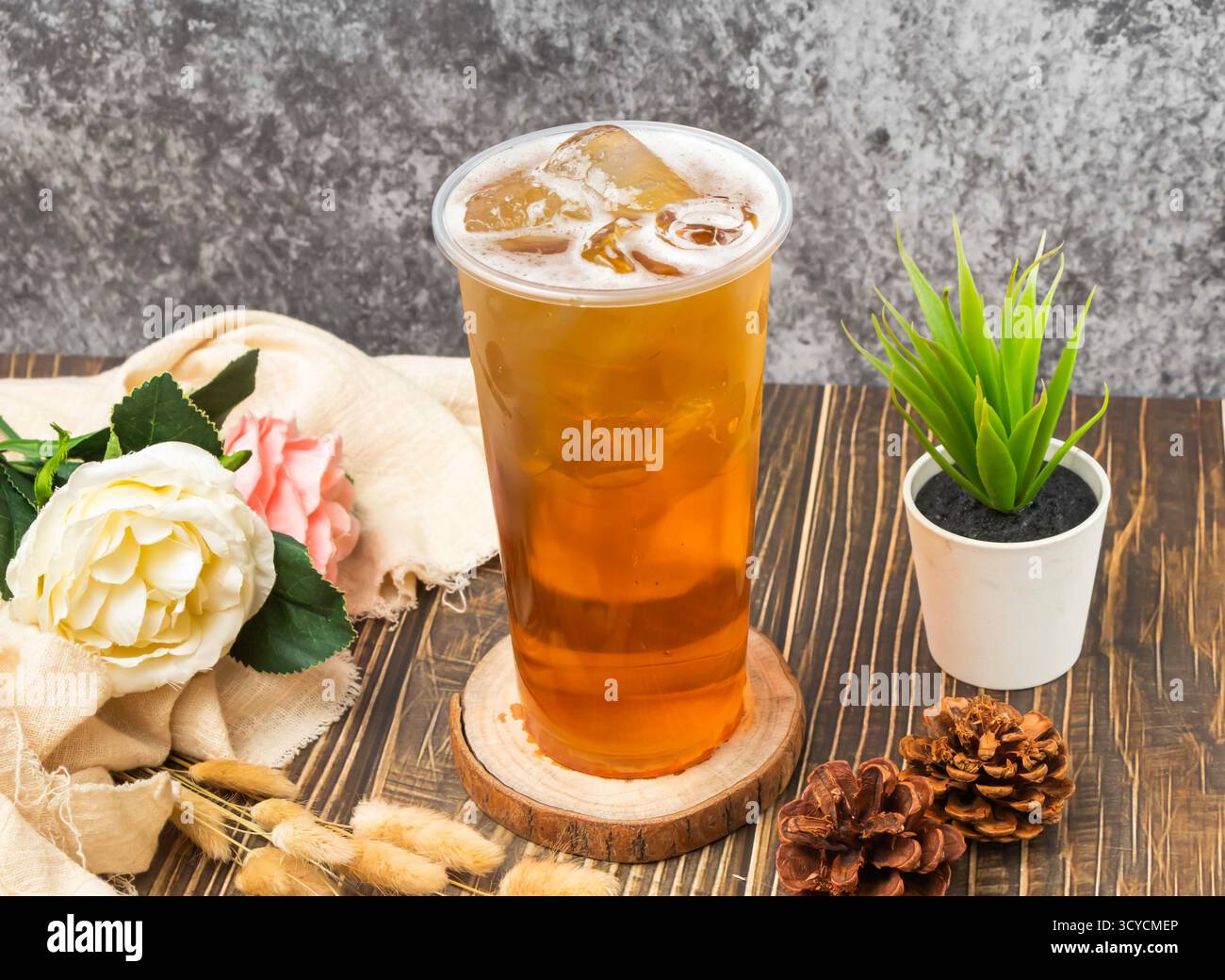iced Ancient wheat tea with ice cube served in disposable glass ...