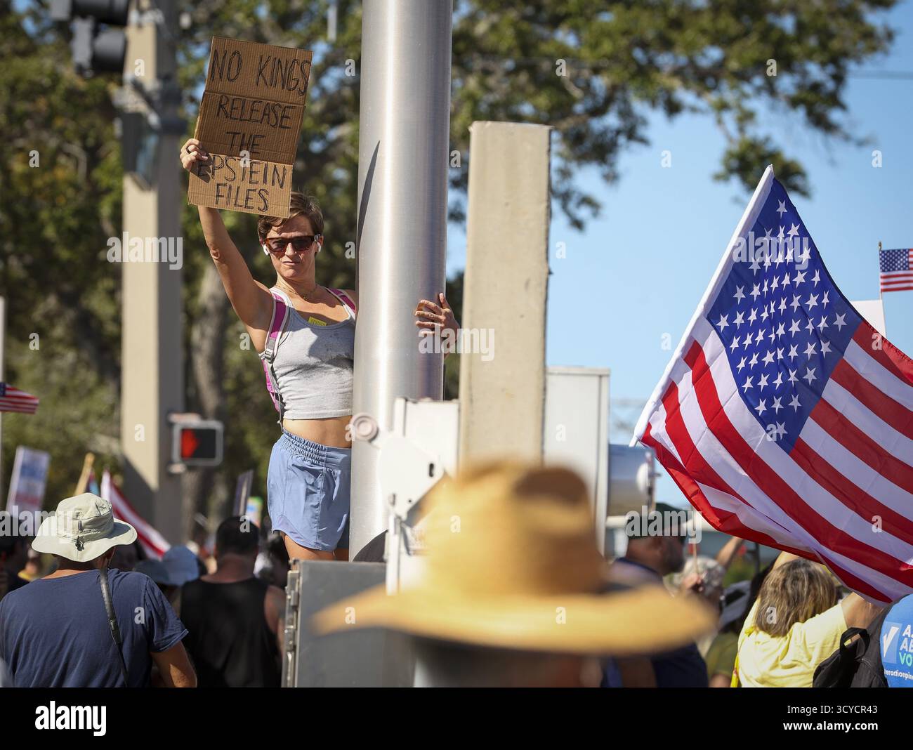 Michelle Hayes, 50, of Clearwate holds a sign during a "No Kings ...
