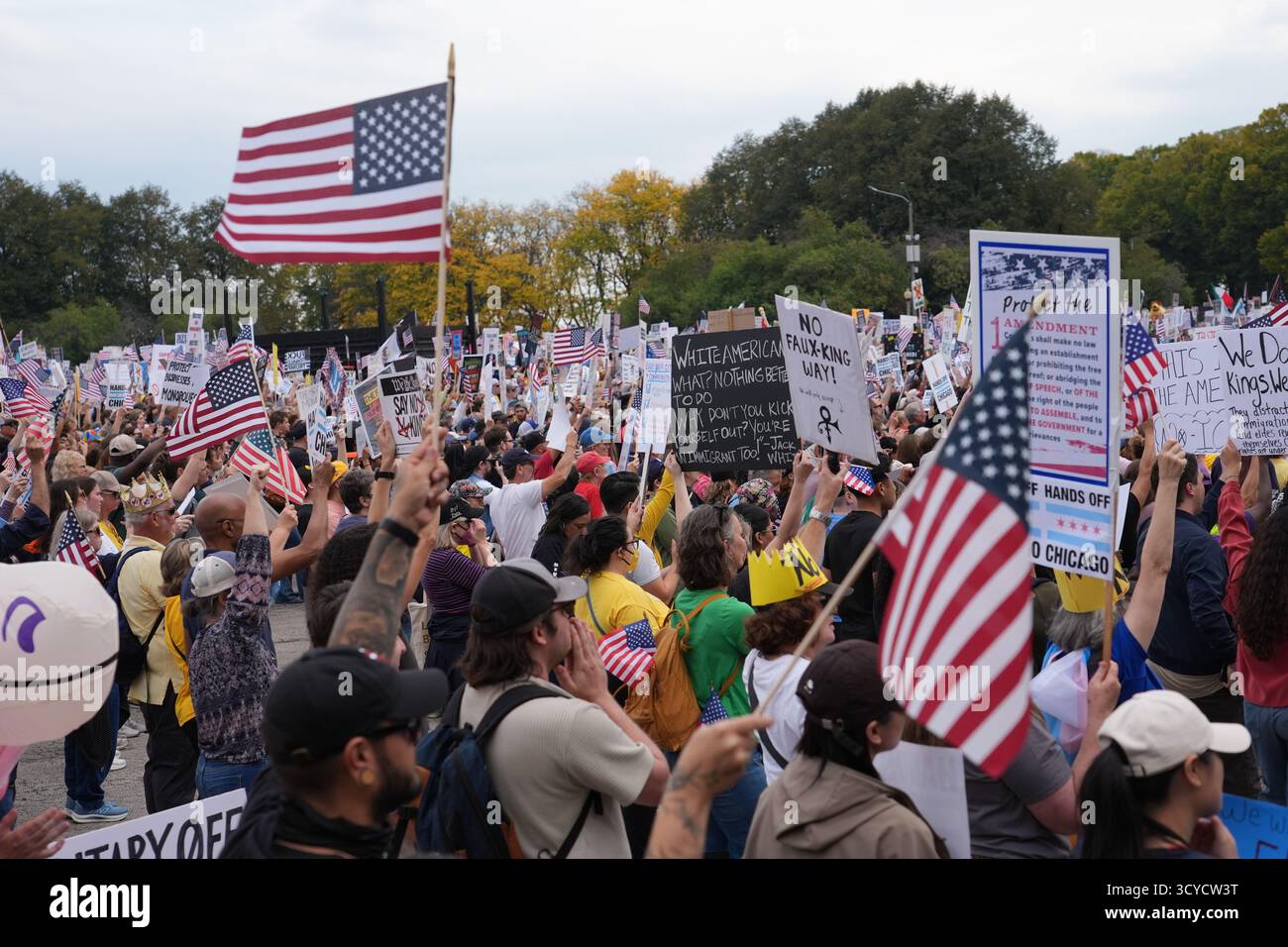 People hold signs and flags during a "No Kings" protest Saturday, Oct ...