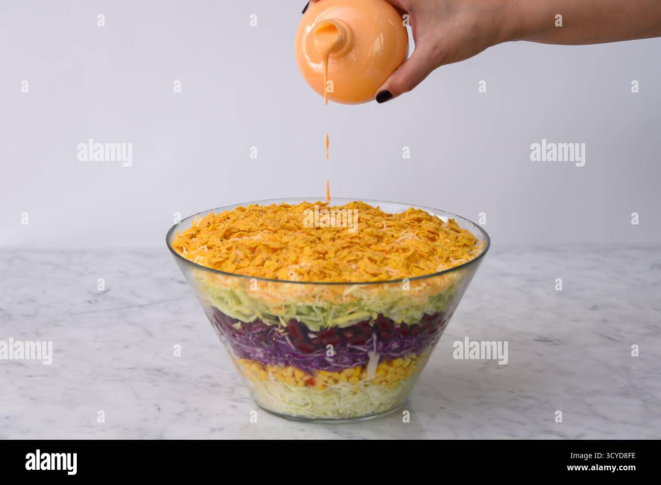 Fresh Seven Layer Salad in a clear glass bowl with layers of shredded ...