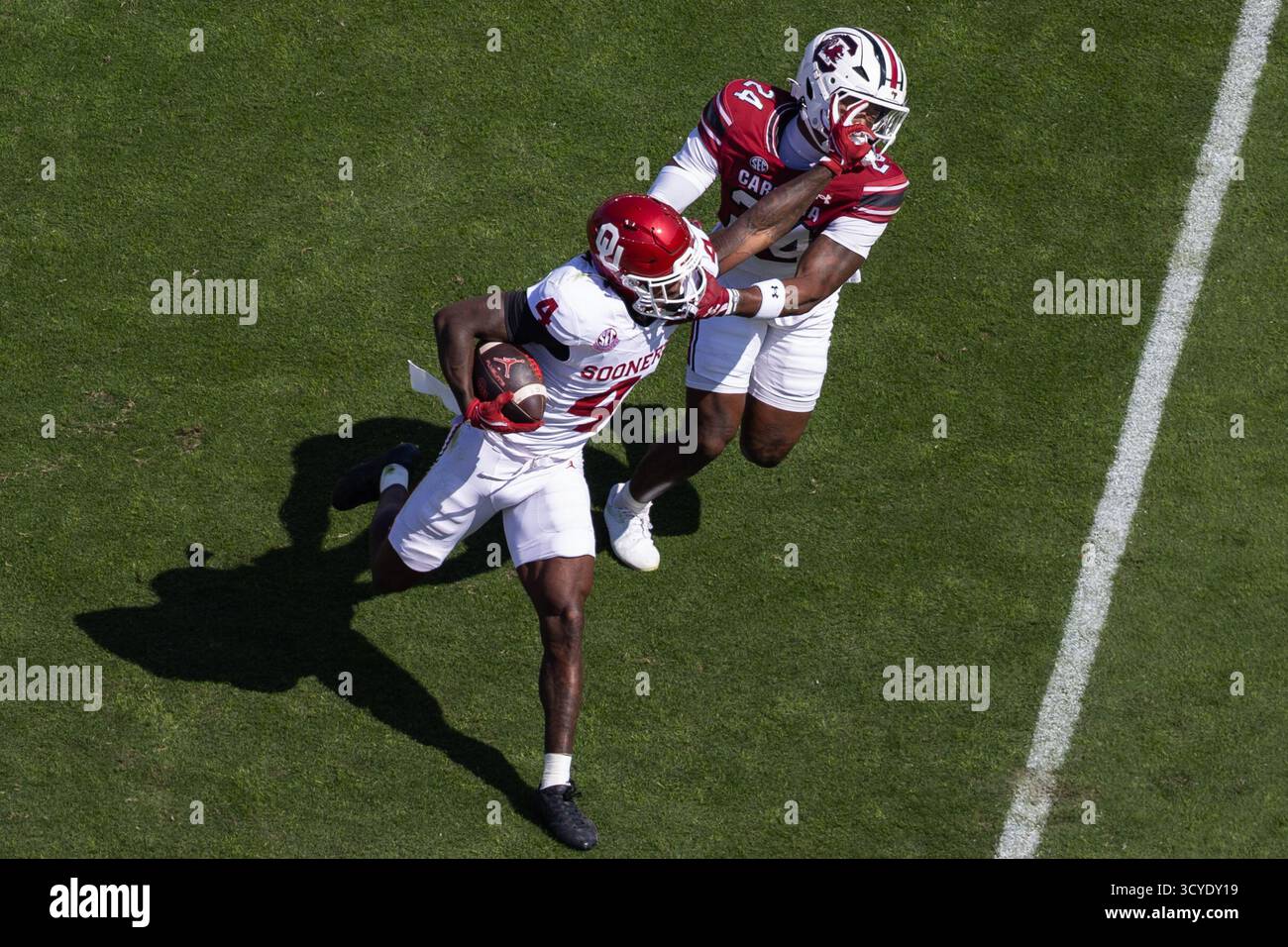 Oklahoma wide receiver Deion Burks (4) stiff-arms South Carolina ...