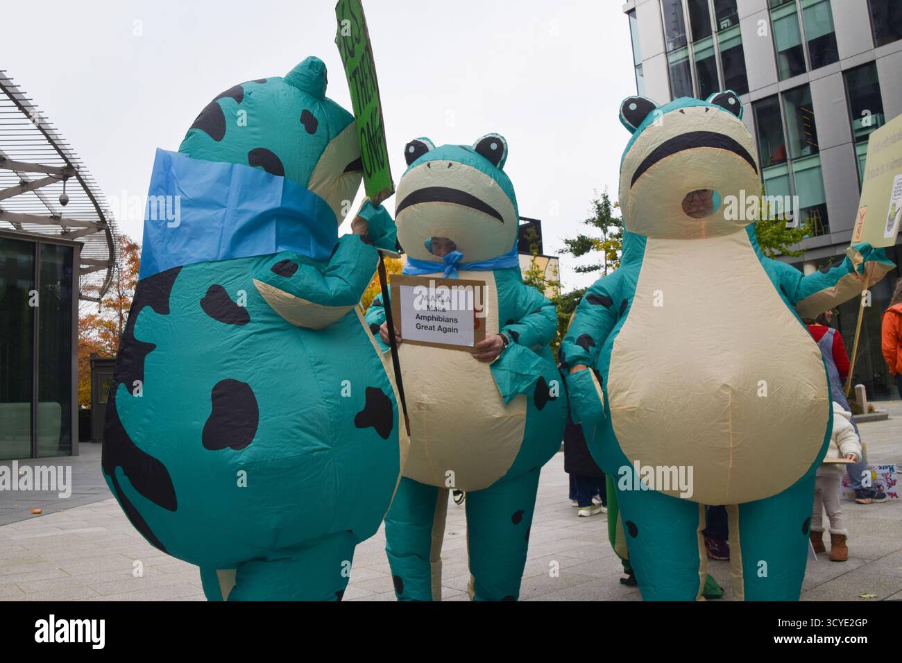 London, UK. 18th October 2025. Protesters wearing inflatable frog ...