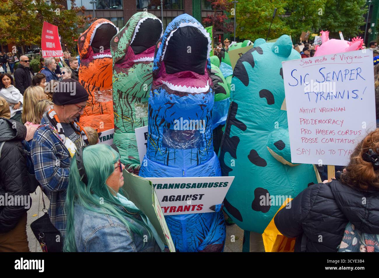 London, UK. 18th October 2025. Protesters wearing inflatable dinosaur ...
